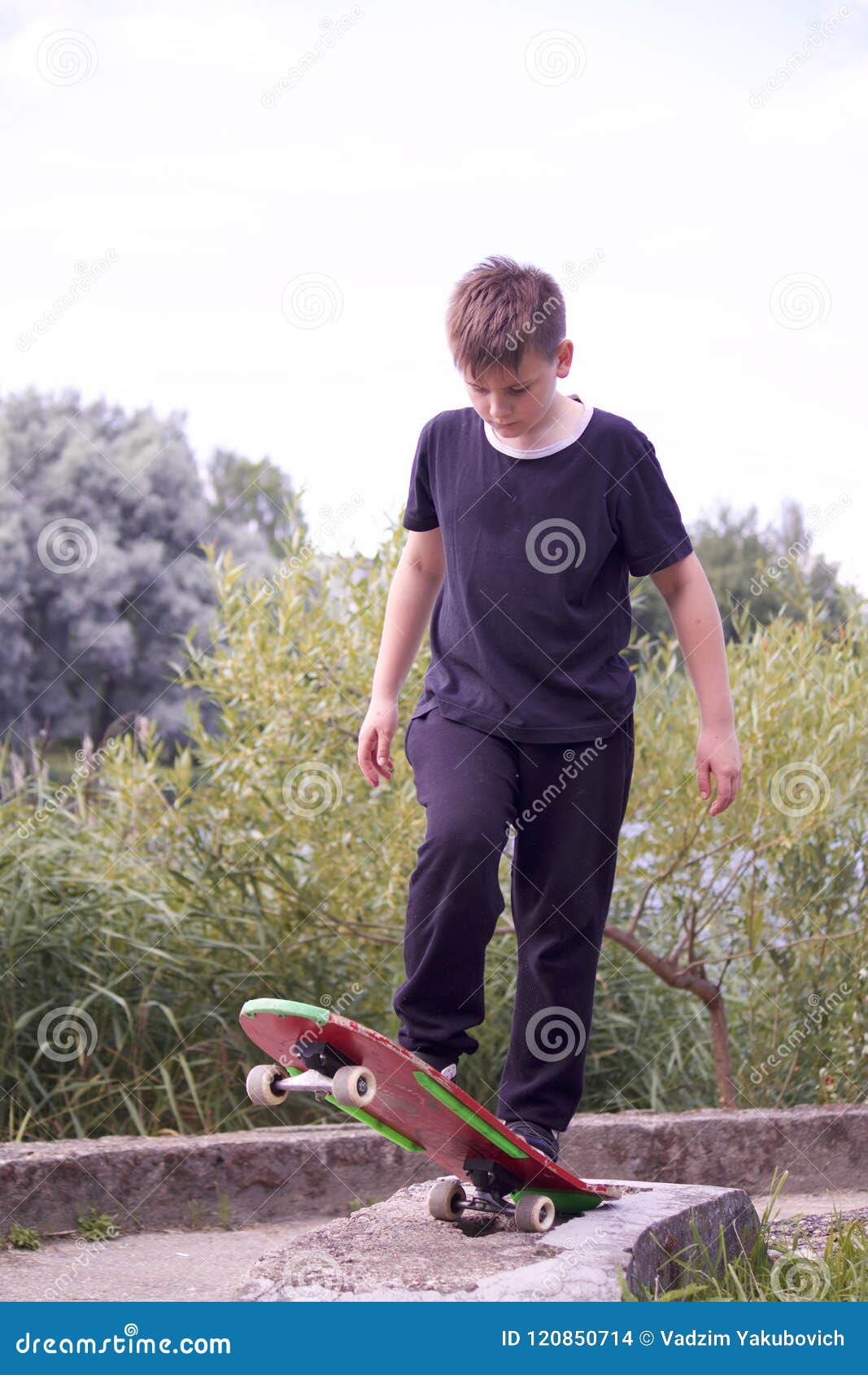 A Teenager is Standing on a Skateboard. Stock Photo - Image of young ...