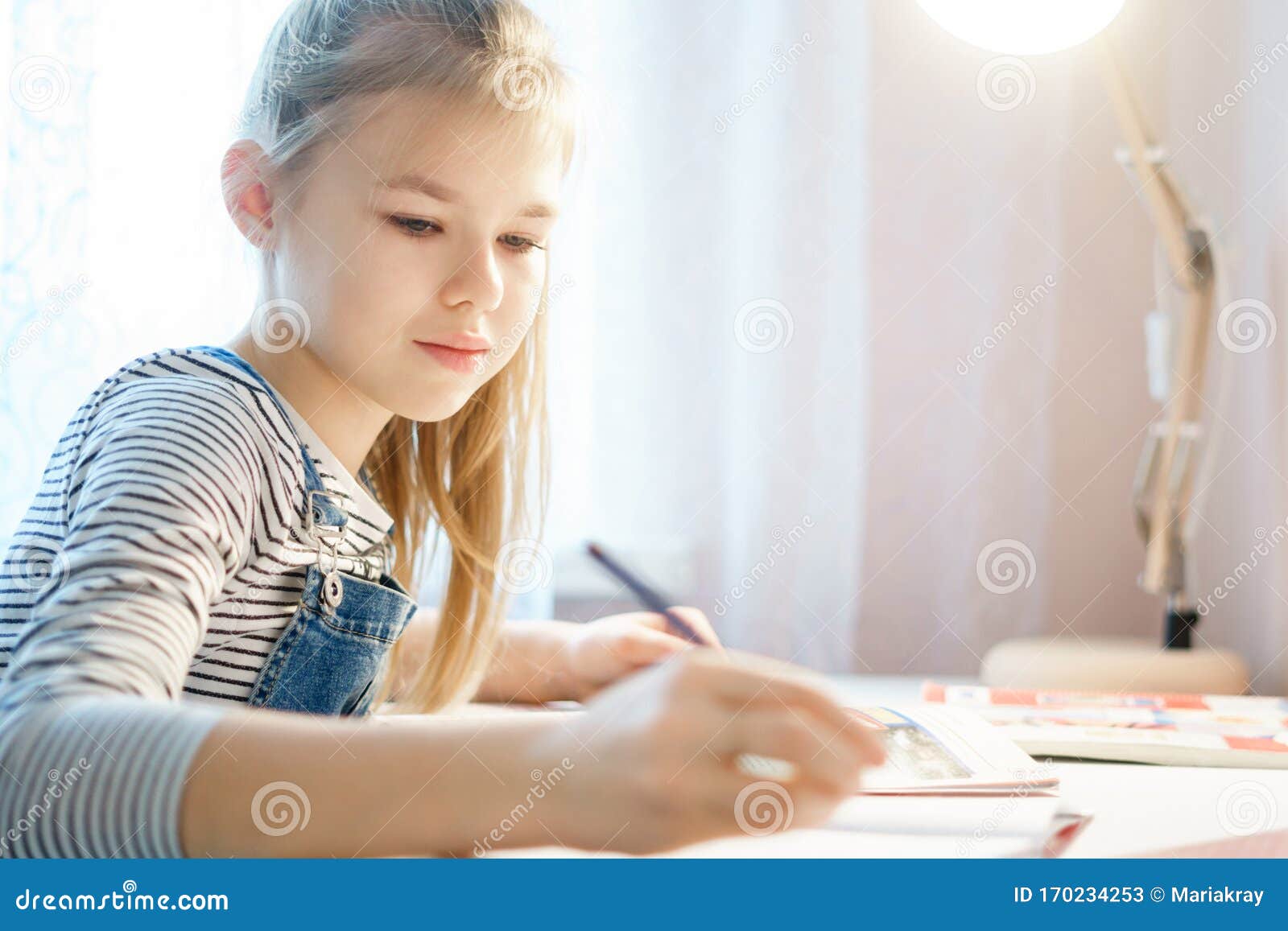 Teenager Studying and Doing Her Homework while Holding Pen and Writing ...
