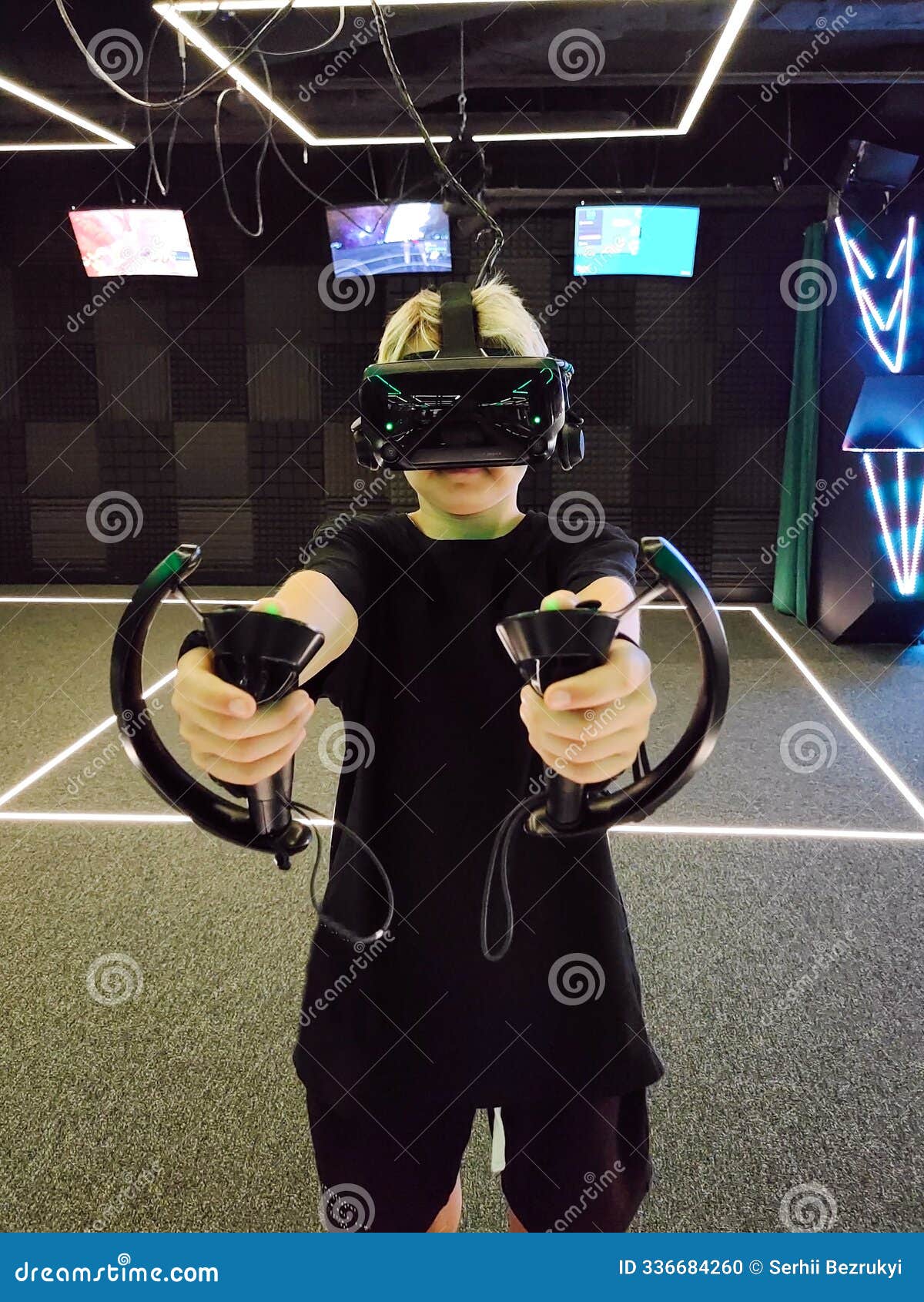A Teenager in VR Glasses with Augmented Reality and with Controllers in ...