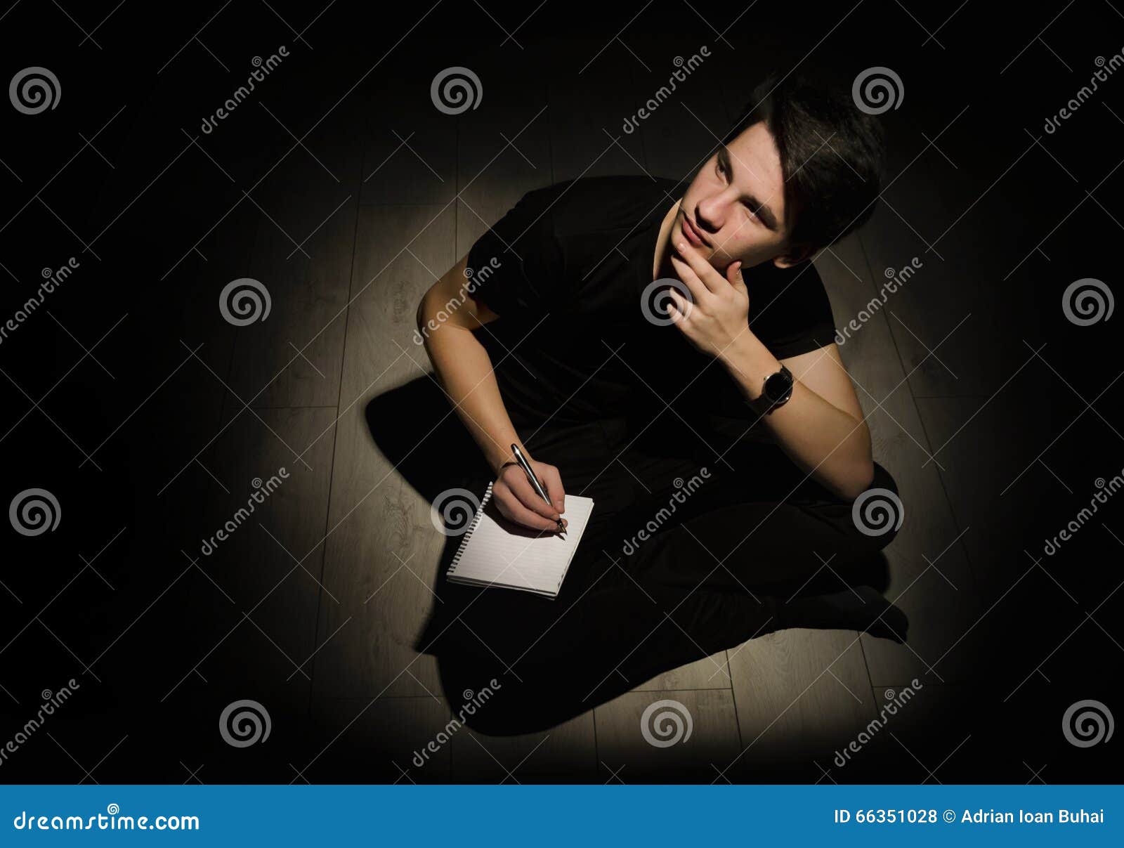 Teenager Young Man Thinking and Writing on Notebook on Black Background ...