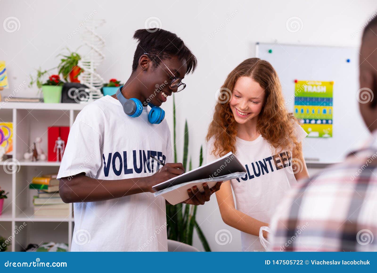 Teenagers Making Notes after Sorting Little in Voluntary Organization ...