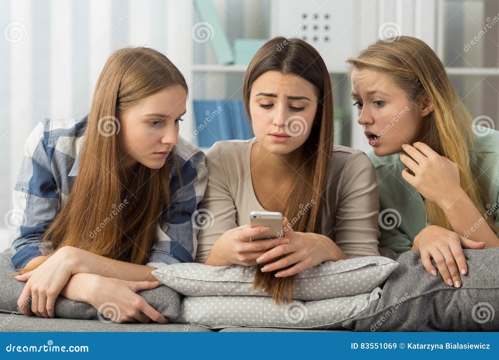 Teenagers Staring Surprised at Mobile Phone Stock Image - Image of ...