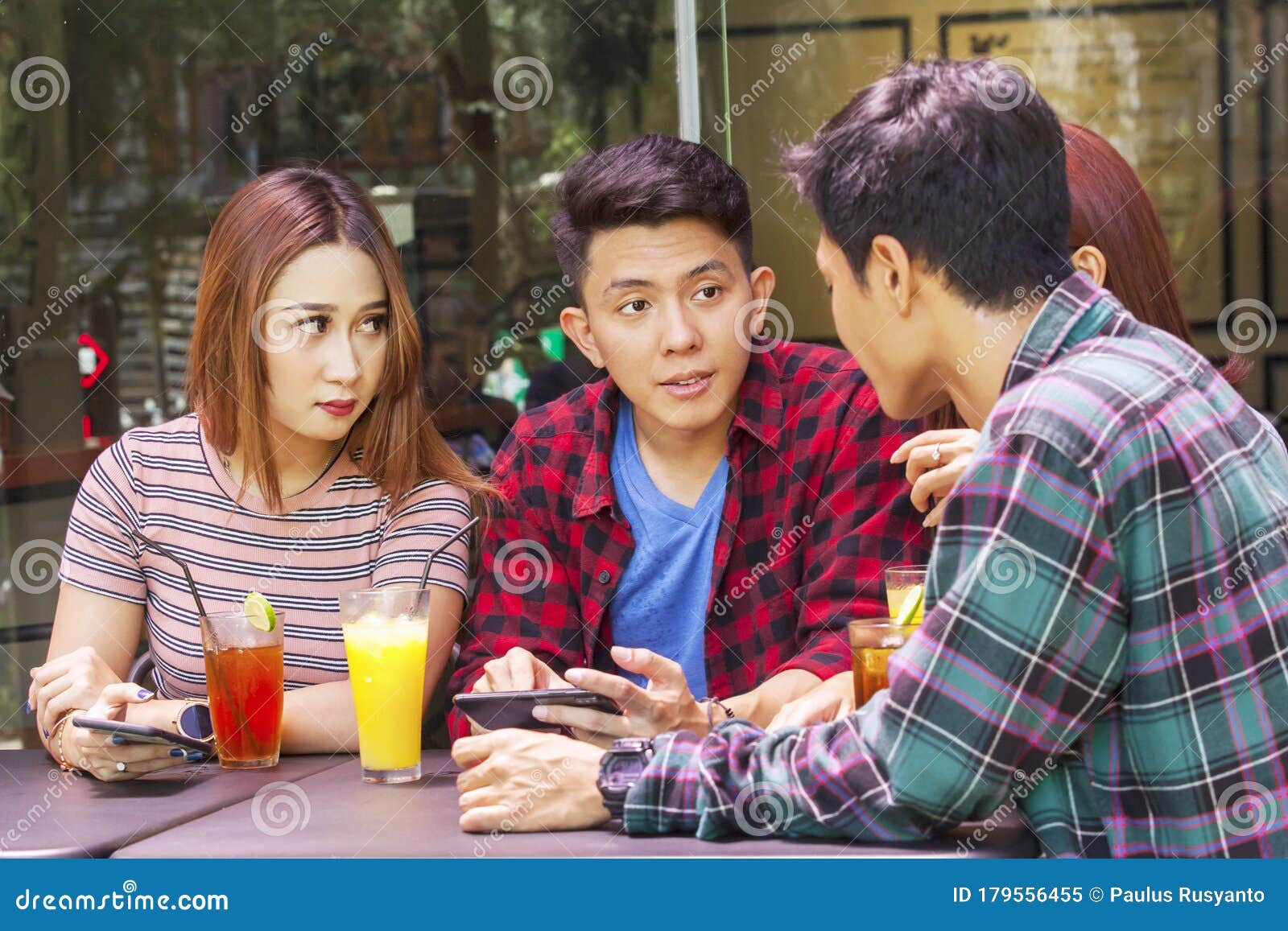 Teenagers Using Cellphone in Restaurant Stock Image - Image of people ...