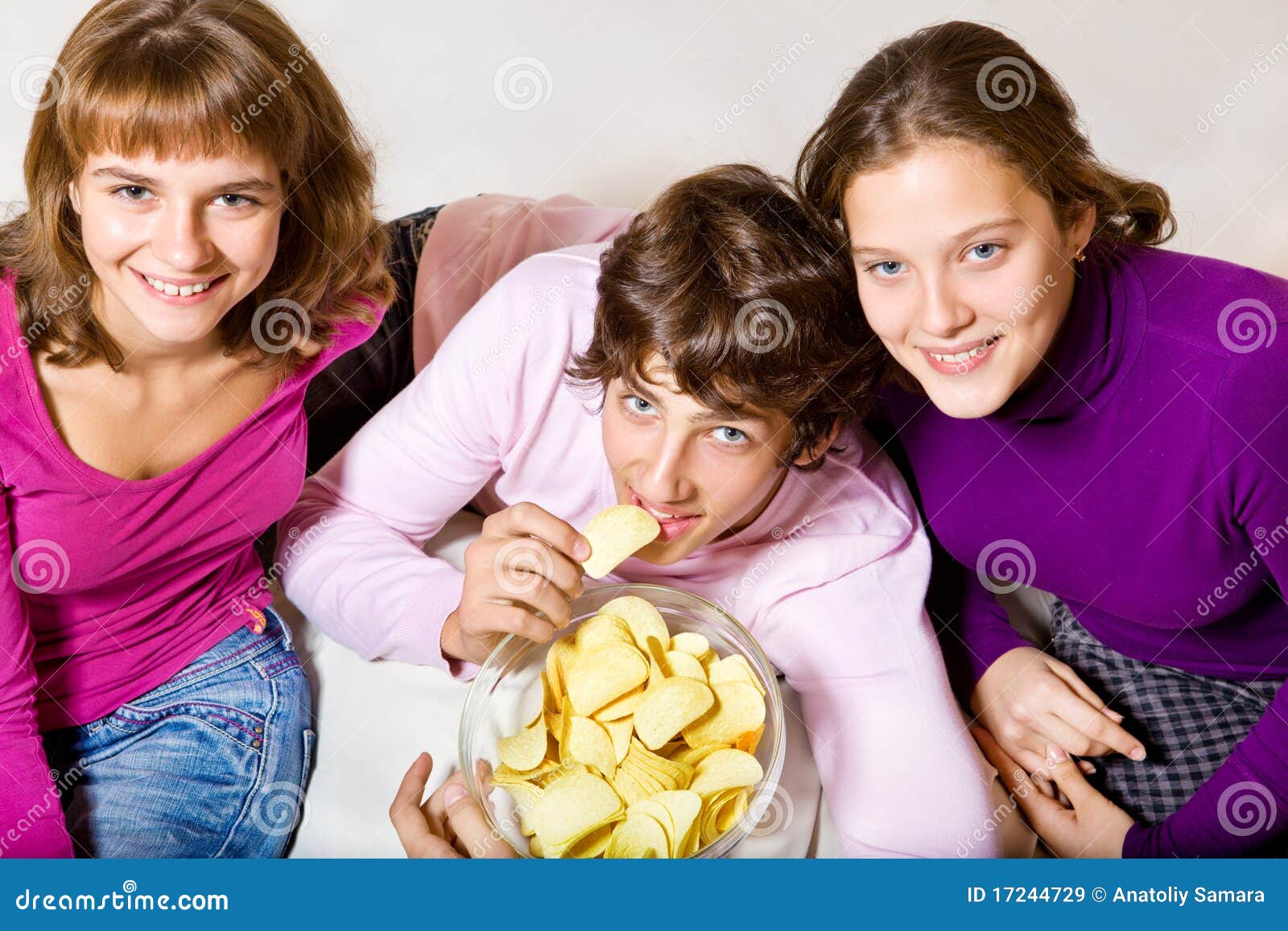 Teens eating crisps stock image. Image of cute, happiness - 17244729