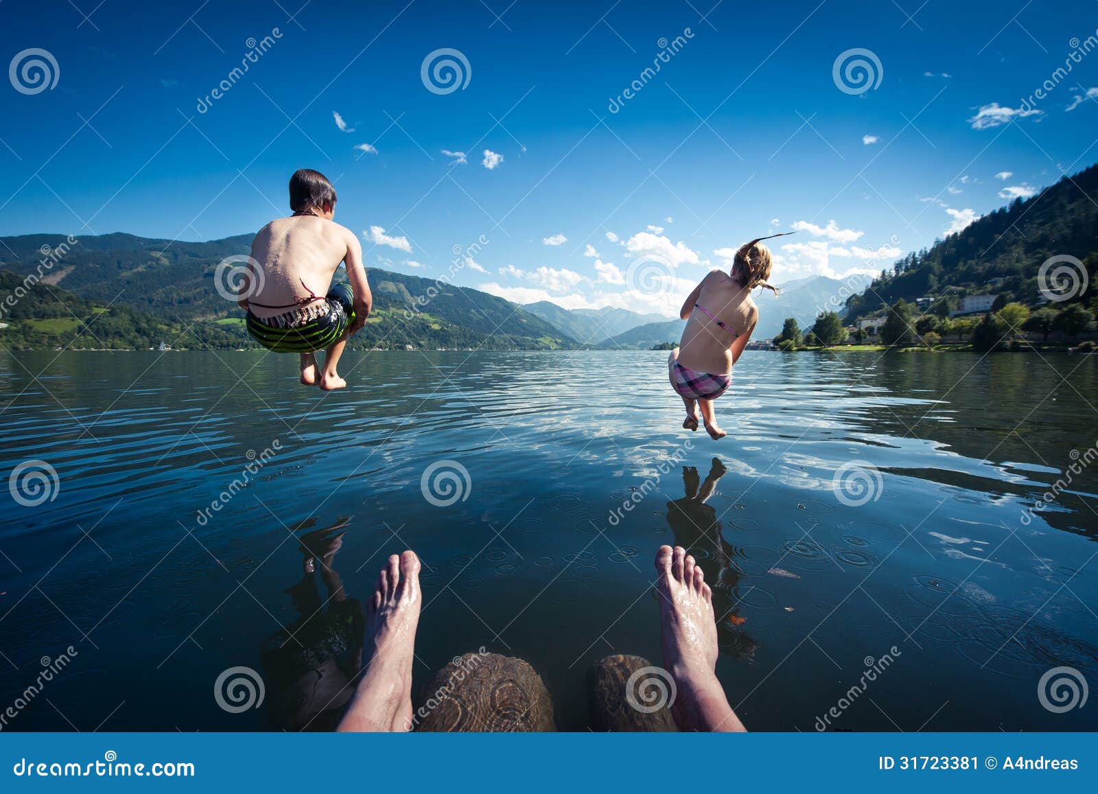 Teens jumping into lake stock image. Image of play, person - 31723381