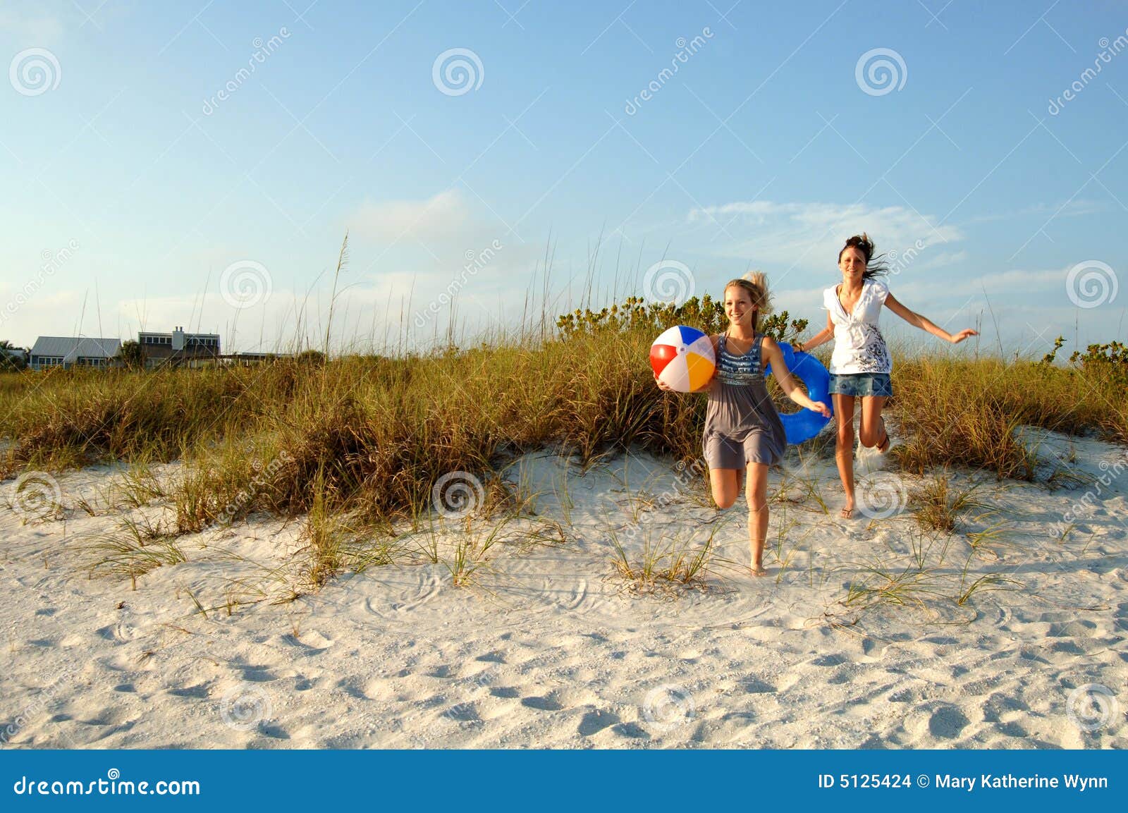 Teens running to the beach stock photo. Image of sand - 5125424