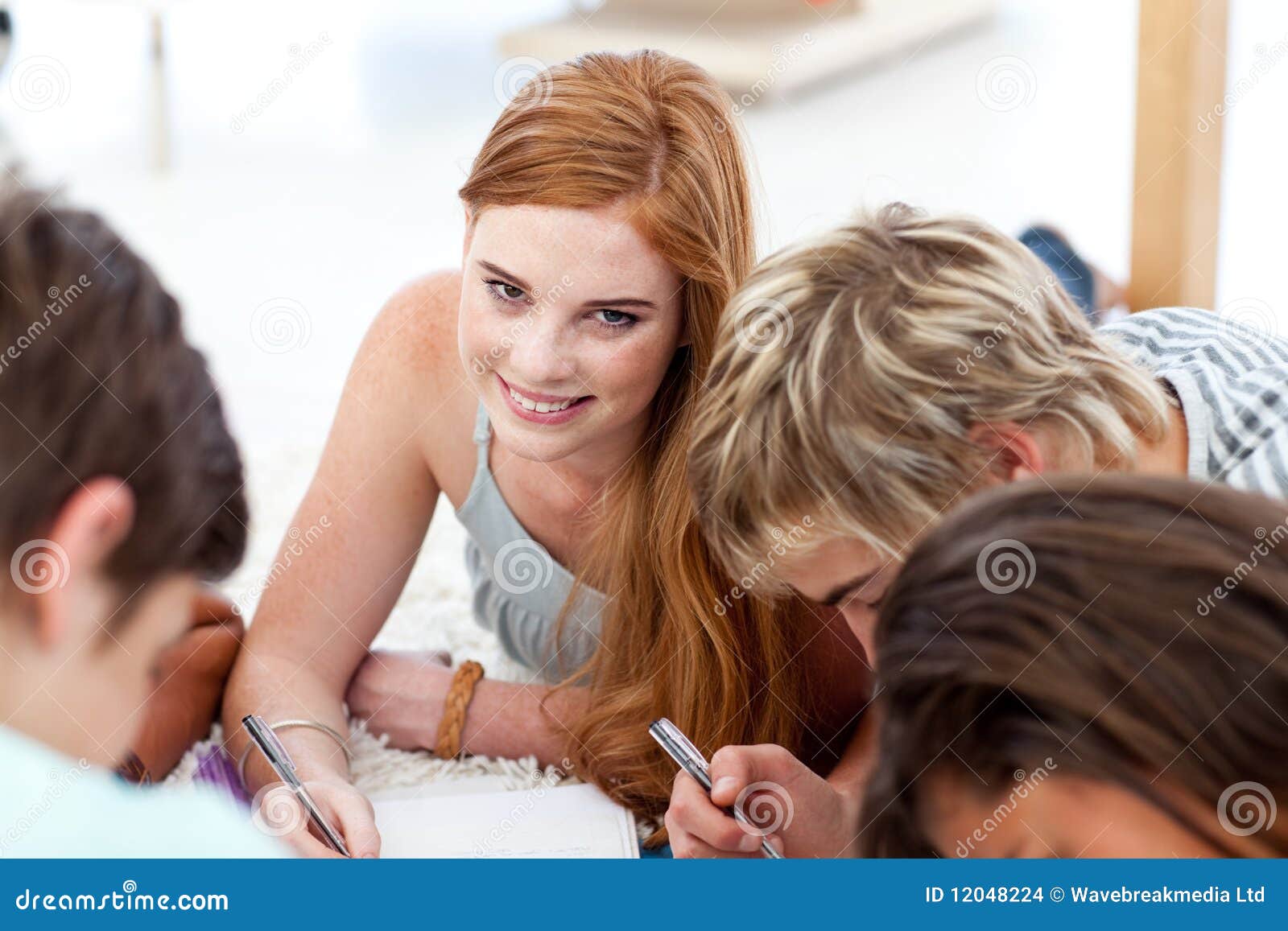 Teens Studying Together Lying on the Floor Stock Photo - Image of ...