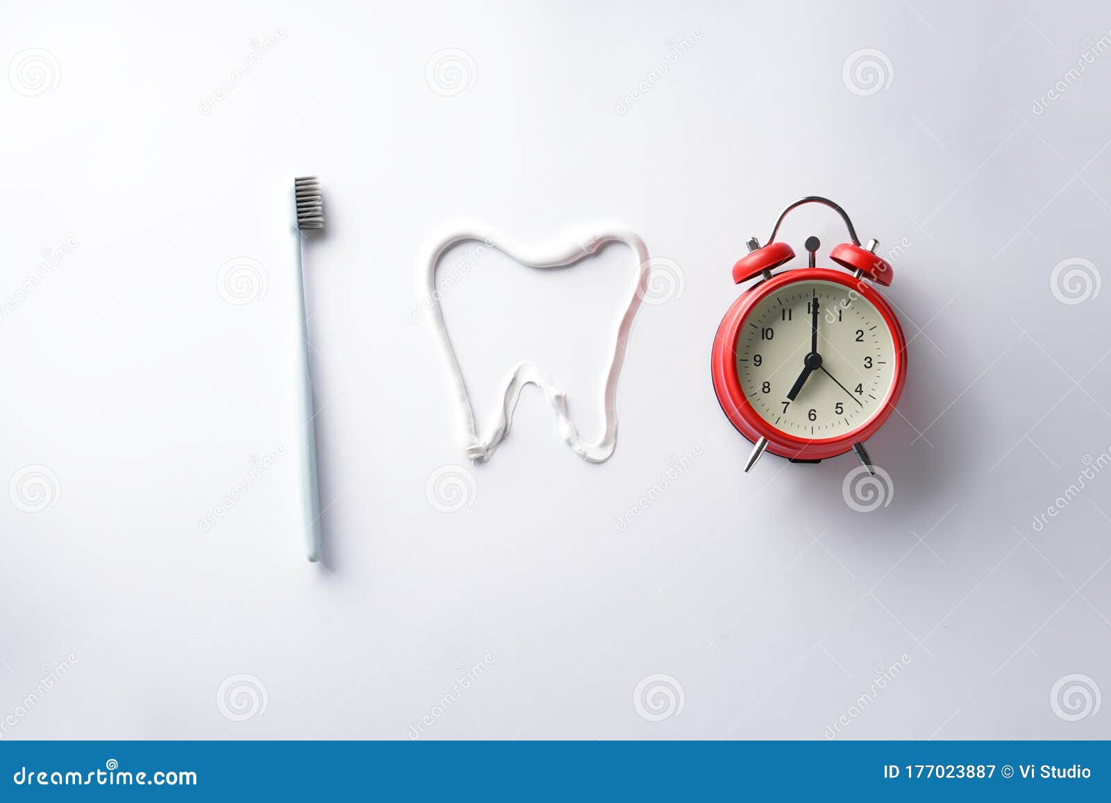 Toothbrush and Alarm Clock on a White Background. Teeth Brushing ...