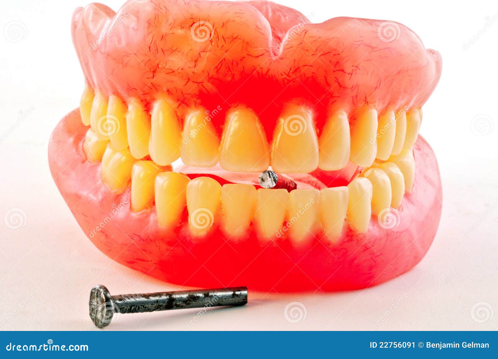 Teeth and an iron nail stock image. Image of false, teeth - 22756091