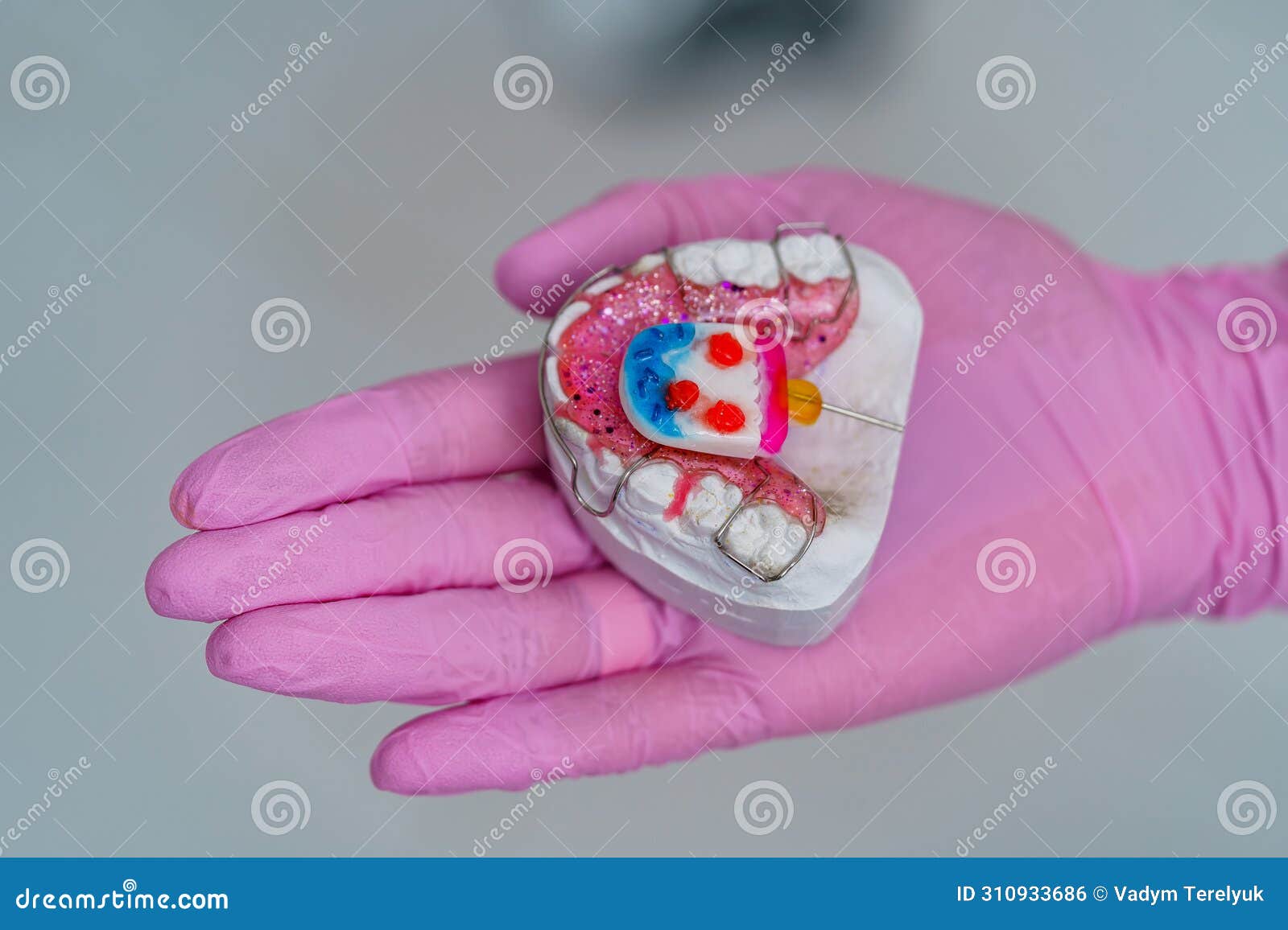Teeth Model on Hand on Blurred Background. Plastic Teeth in One Row ...
