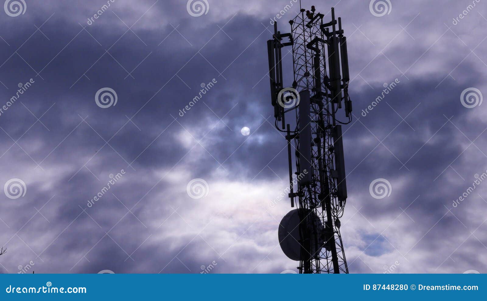 Telecommunication Tower with Clouds and Sun in Background Stock Photo ...