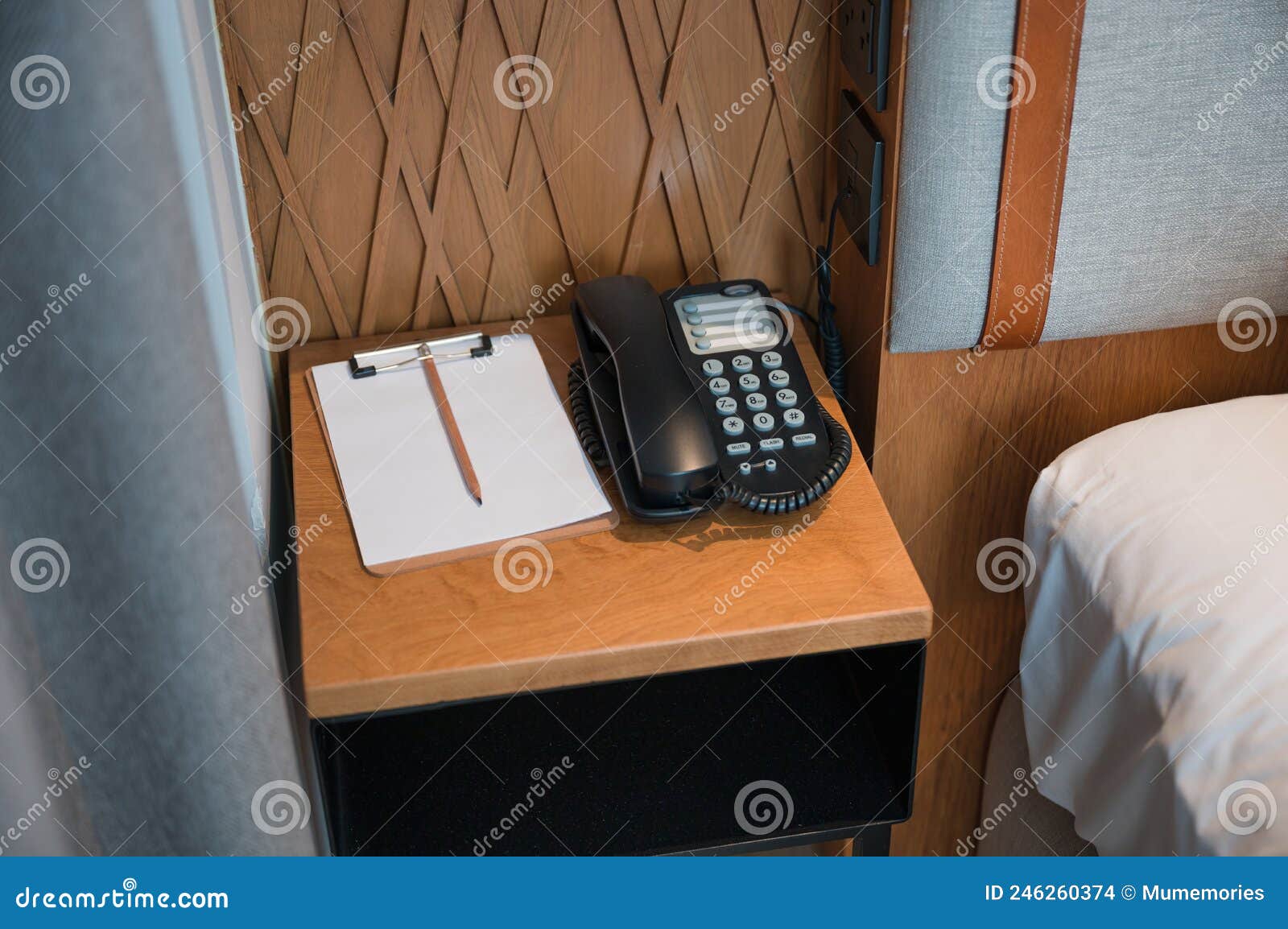 Telephone with Paper Notebook, Pencil on Bedside Table in Bedroom Stock ...