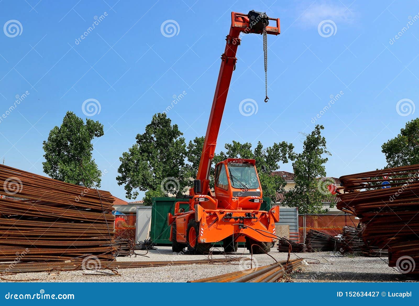 A Telescopic Handler Loader among Steel Bars in a Construction Site ...