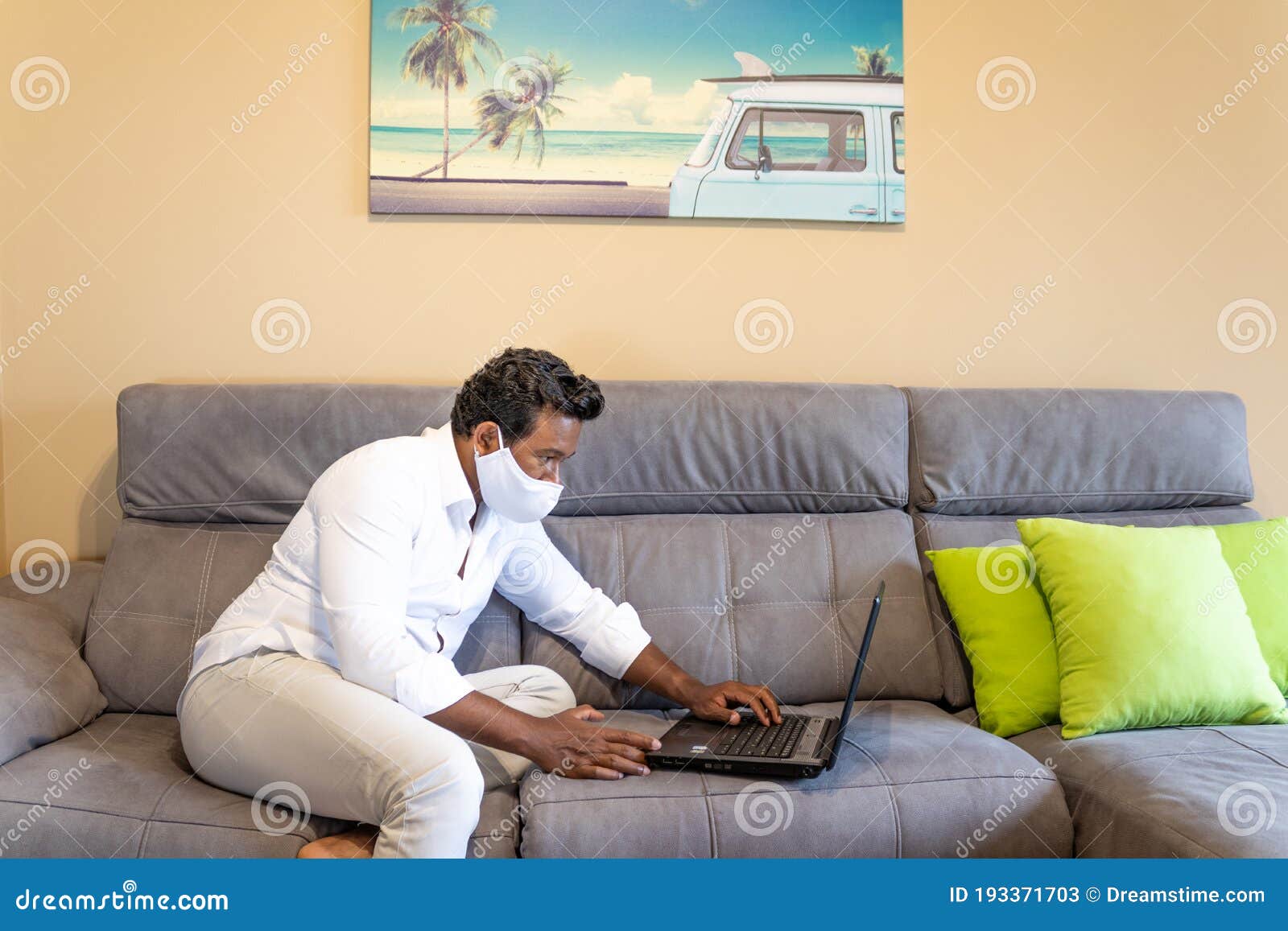 Teleworker Man Sitting on the Couch at Home. Laptop and Mobile Computer ...