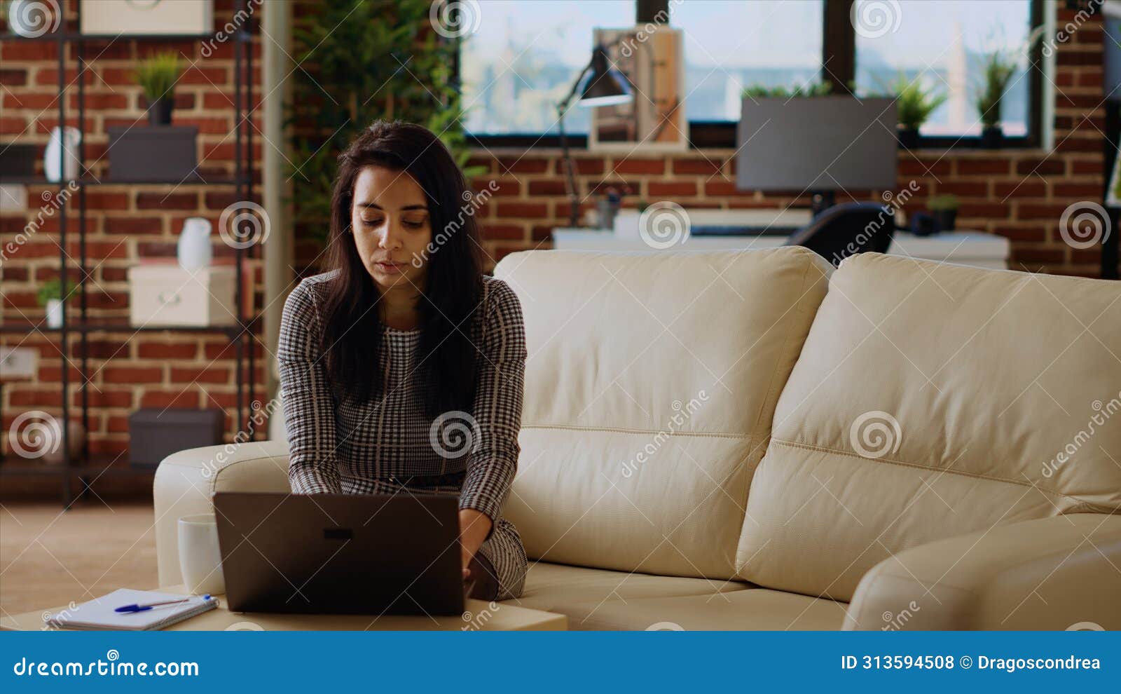 Teleworker Sitting on Couch, Focused on Finishing Tasks in Personal ...
