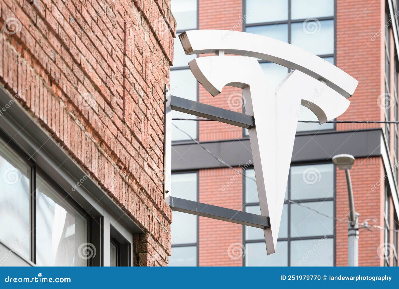 Tesla Symbol Hanging on a Brick Wall in Seattle Editorial Image - Image ...