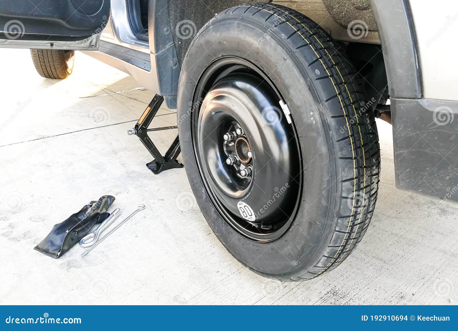 Temporary Emergency Tire Replaced Onto Car Wheel After Flat Tire ...