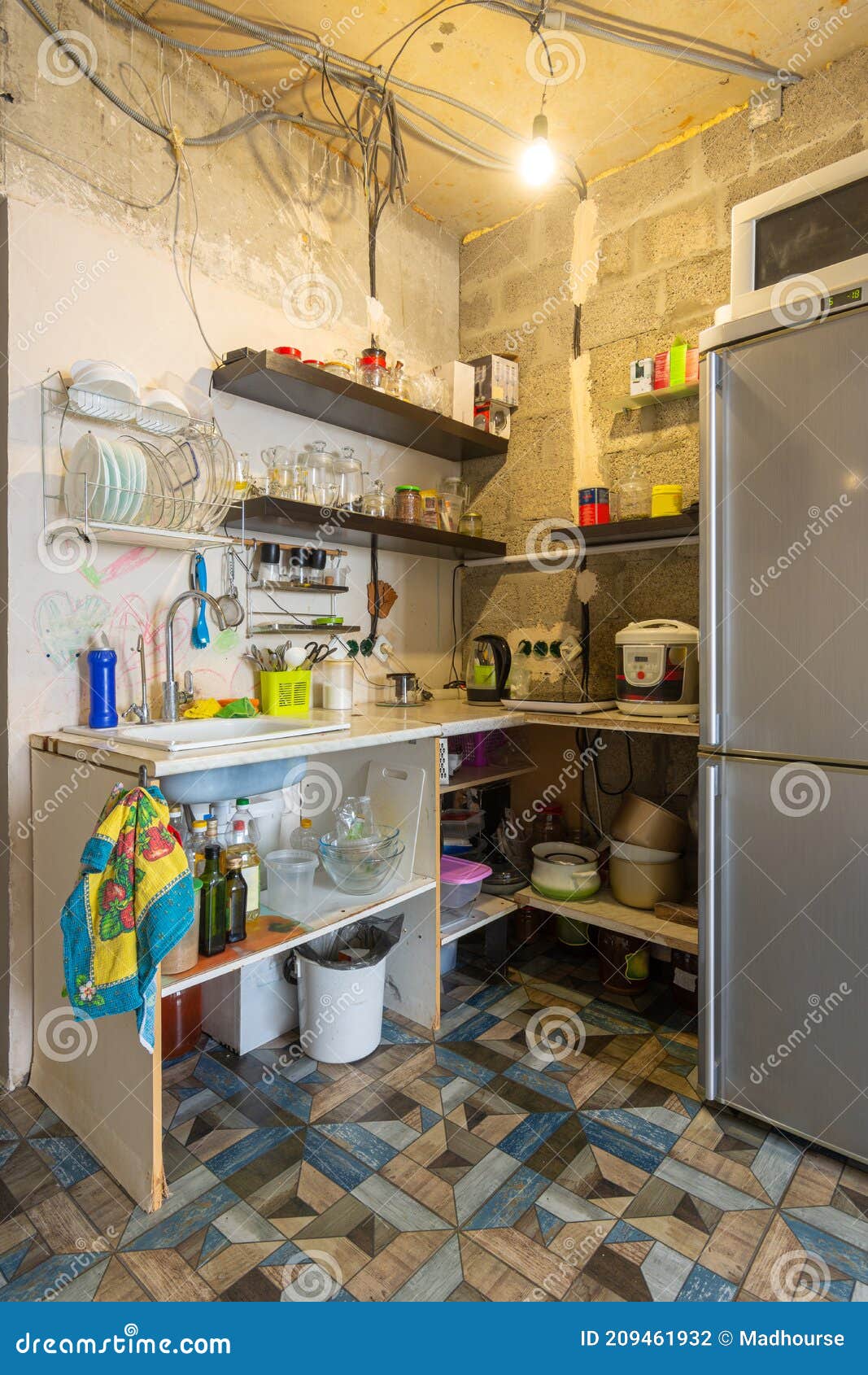 A Temporary Kitchen Made of Planks and Shelves in a Renovated Room ...