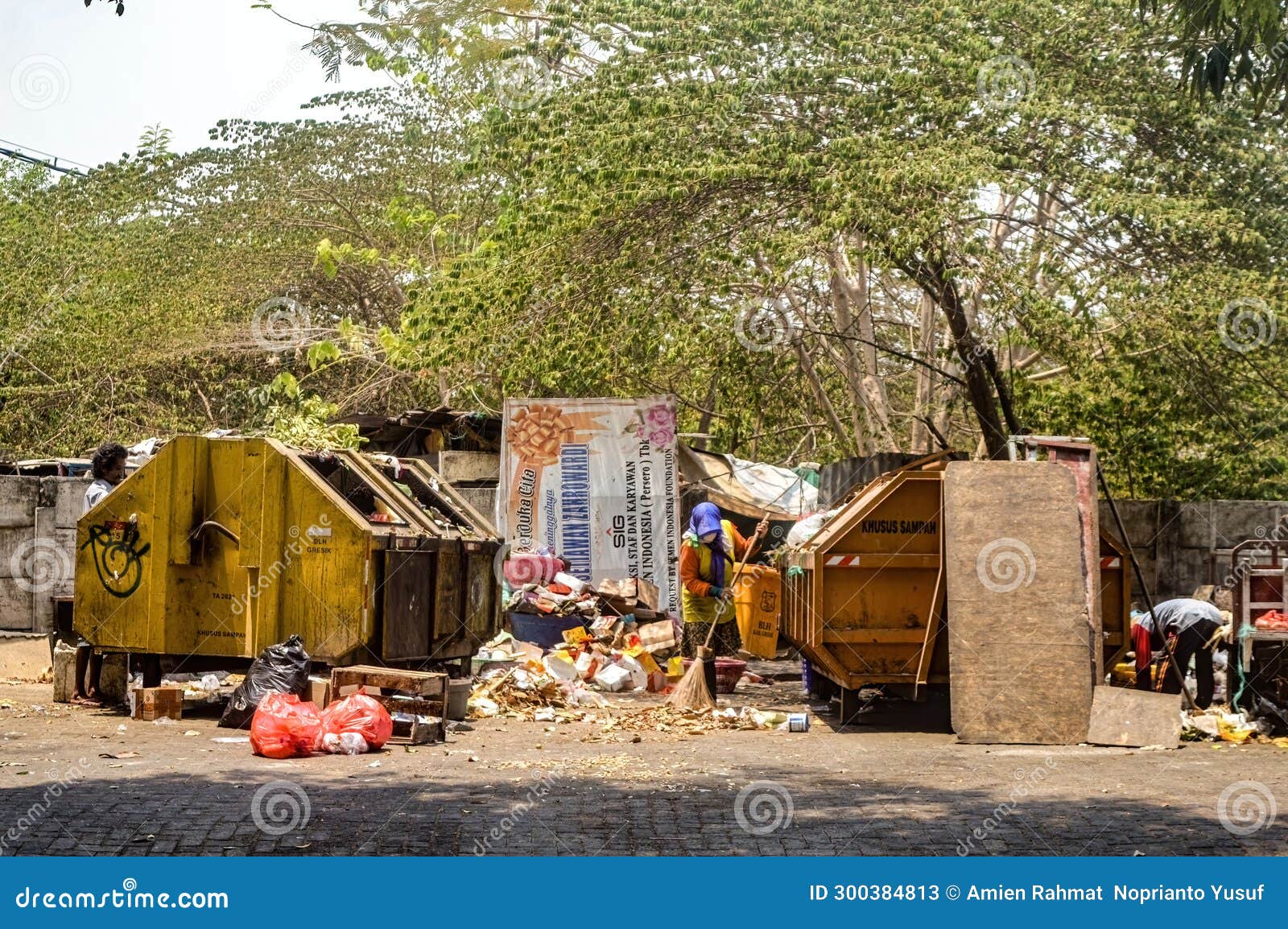 A Temporary Rubbish Dump with Several Scavengers Sorting the Rubbish ...