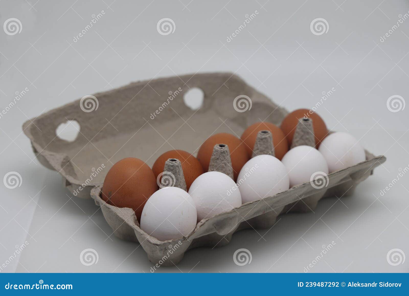 Ten Eggs in a Carton. a Dozen Raw White and Brown Eggs. Stock Photo ...