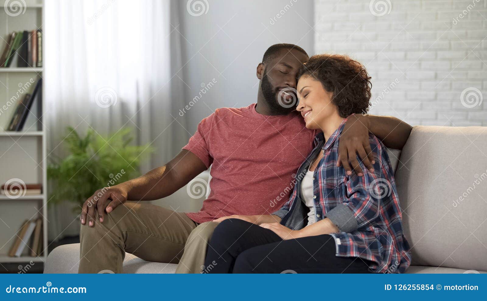 Tender Multiracial Couple Hugging Having Rest In Home Comfort Happy