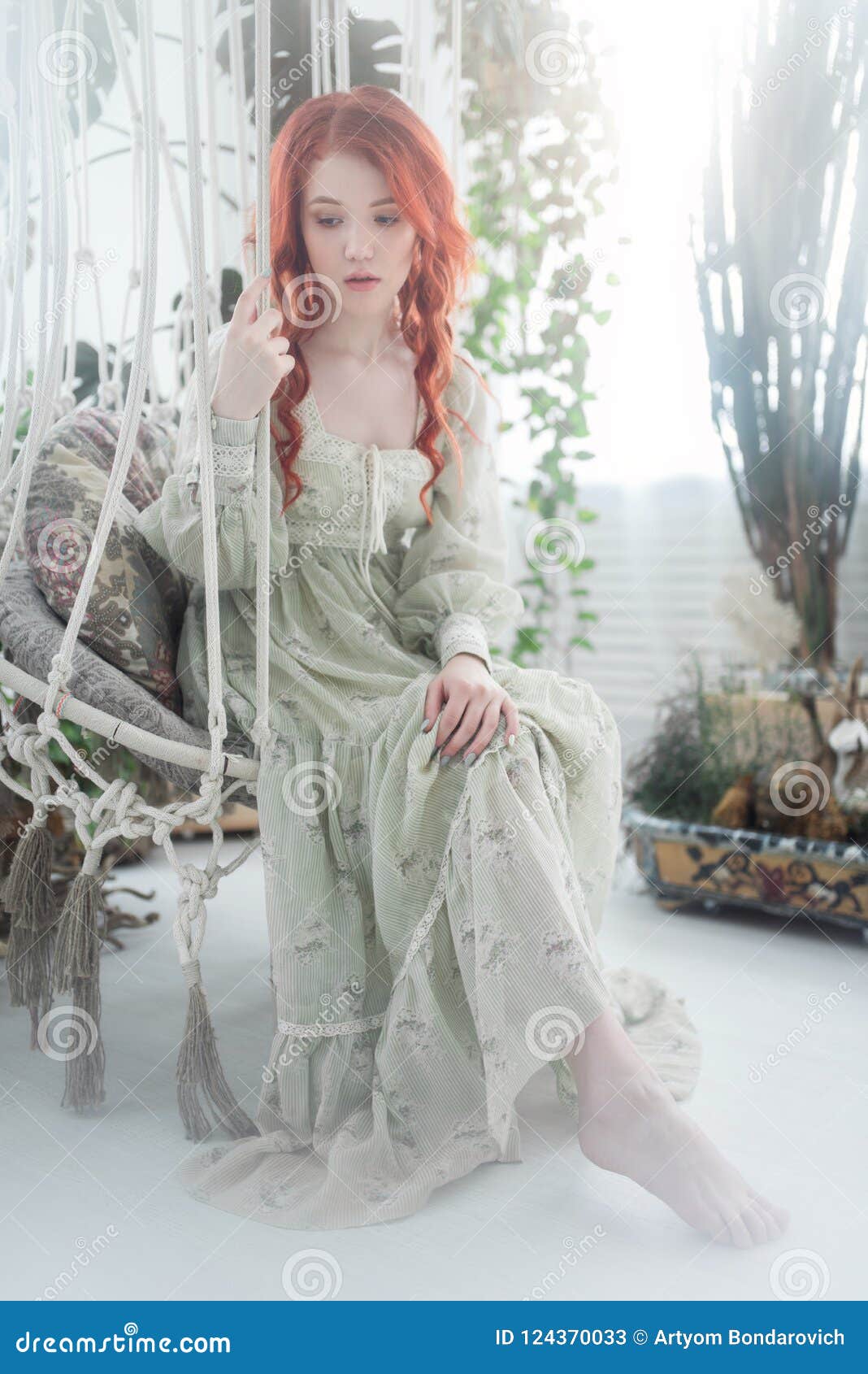 Tender Portrait Of A Young Beautiful Dreamy Redhead Woman Among Foliage