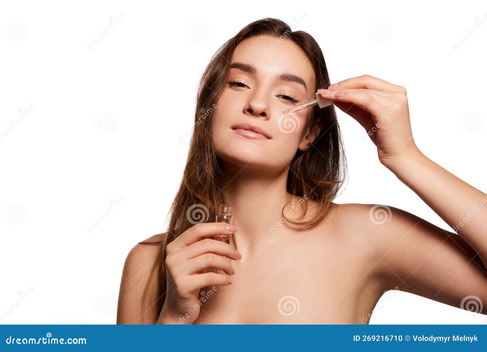 Tender Young Girl With Well Kept Skin Applying Face Serum Moisturizer