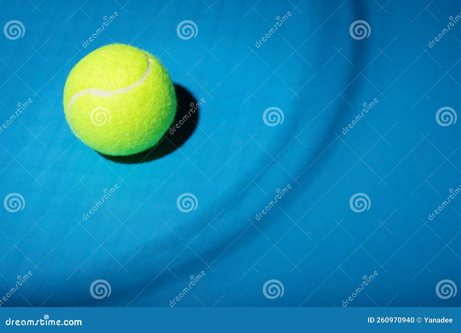 Tennis Ball in the Shadow of a Racket on a Blue Background Stock Photo ...