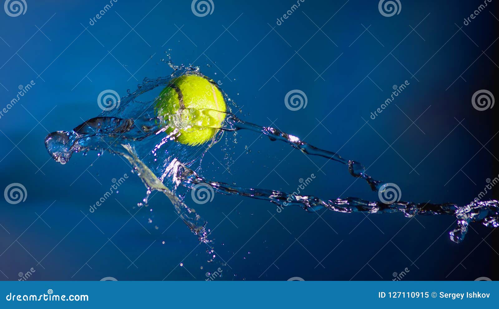 Tennis Ball and Splashes of Water on a Blue Background Stock Image ...