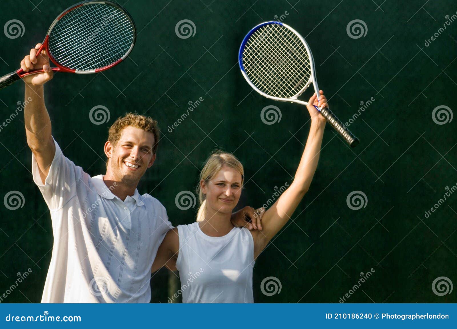 Tennis Partners Raising Rackets in Victory Stock Photo - Image of adult ...