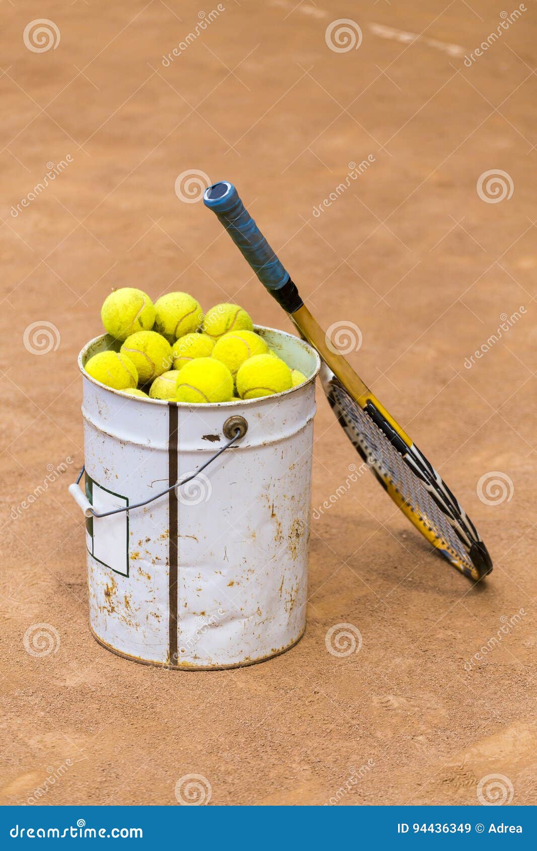 Bucket Filled with Tennis Balls and a Tennis Racket Stock Image - Image ...