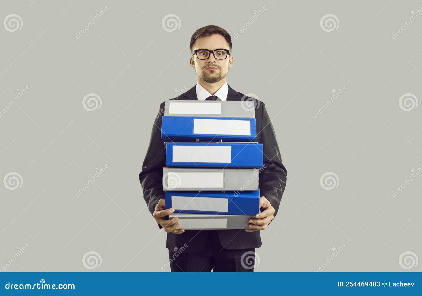 Tense Male Office Worker with Stressed Expression Holding Stack of ...