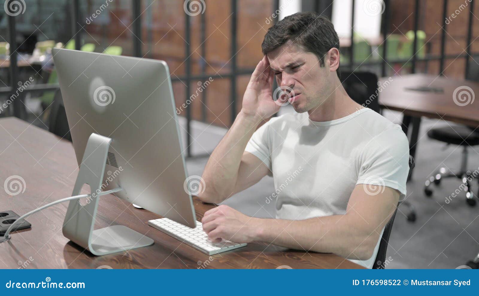 Tense Young Man with Headache at Work Stock Photo - Image of grief ...