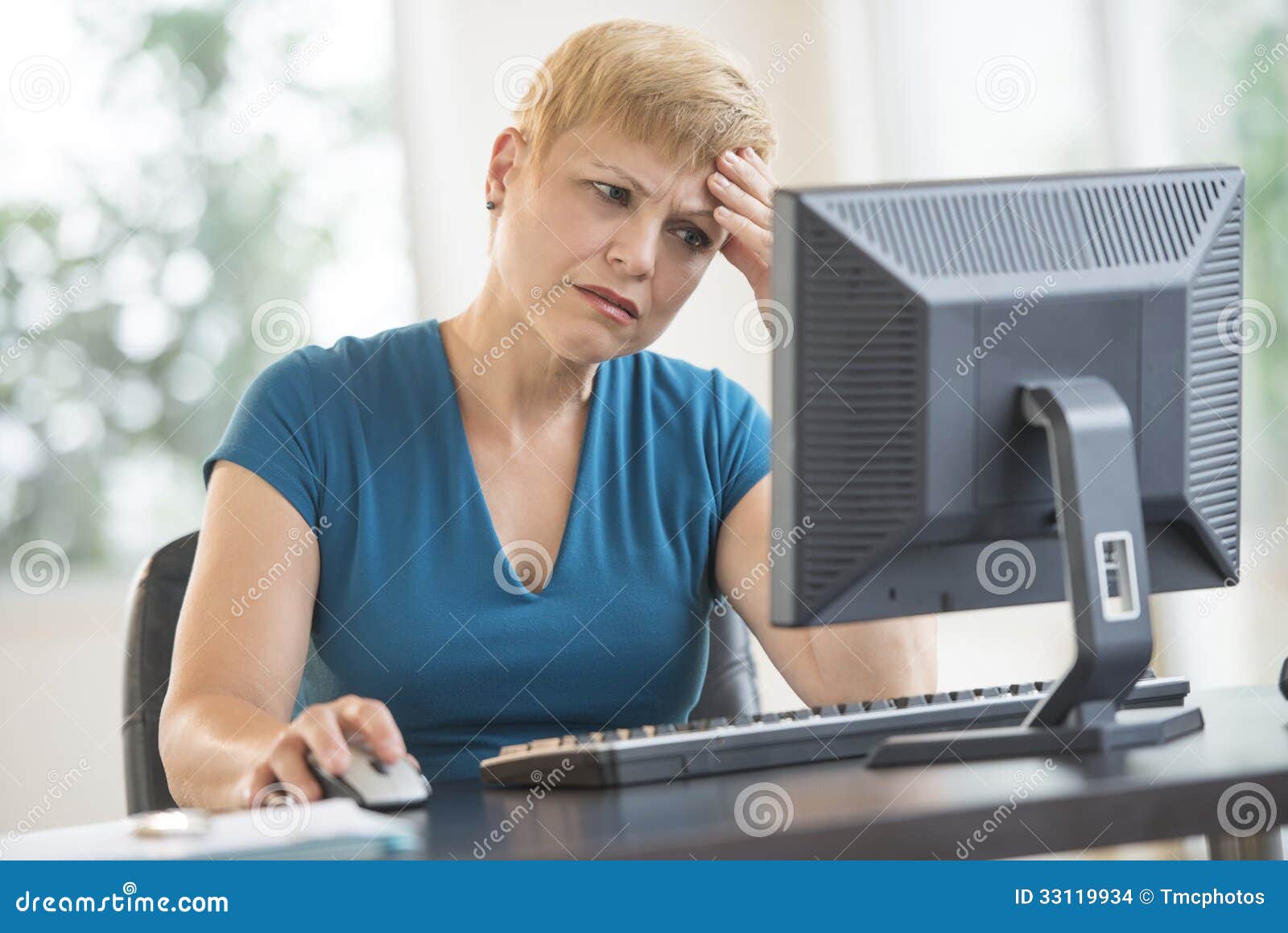 Tensed Businesswoman Using Computer at Desk Stock Photo - Image of ...