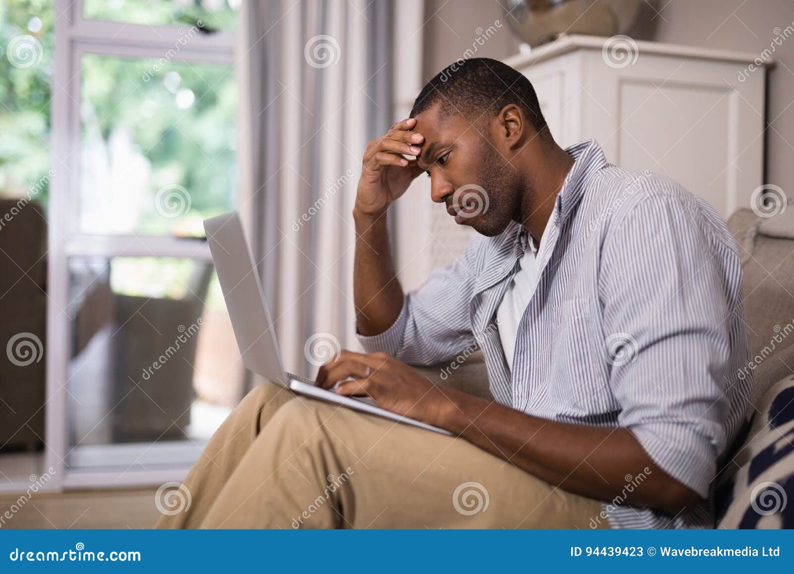 Tensed Man Using Laptop while Sitting at Home Stock Image - Image of ...