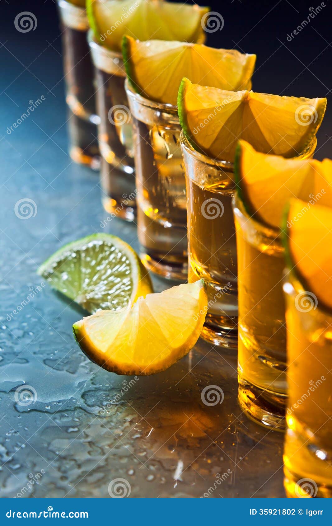 Tequila and Lime on Glass Table Stock Photo - Image of group, beverage ...