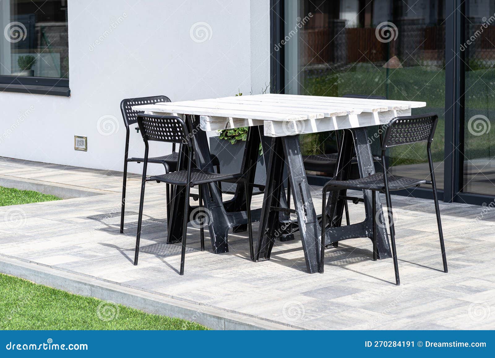Terrace Table Made of White Pallet Standing on Plastic Trestles, Black ...