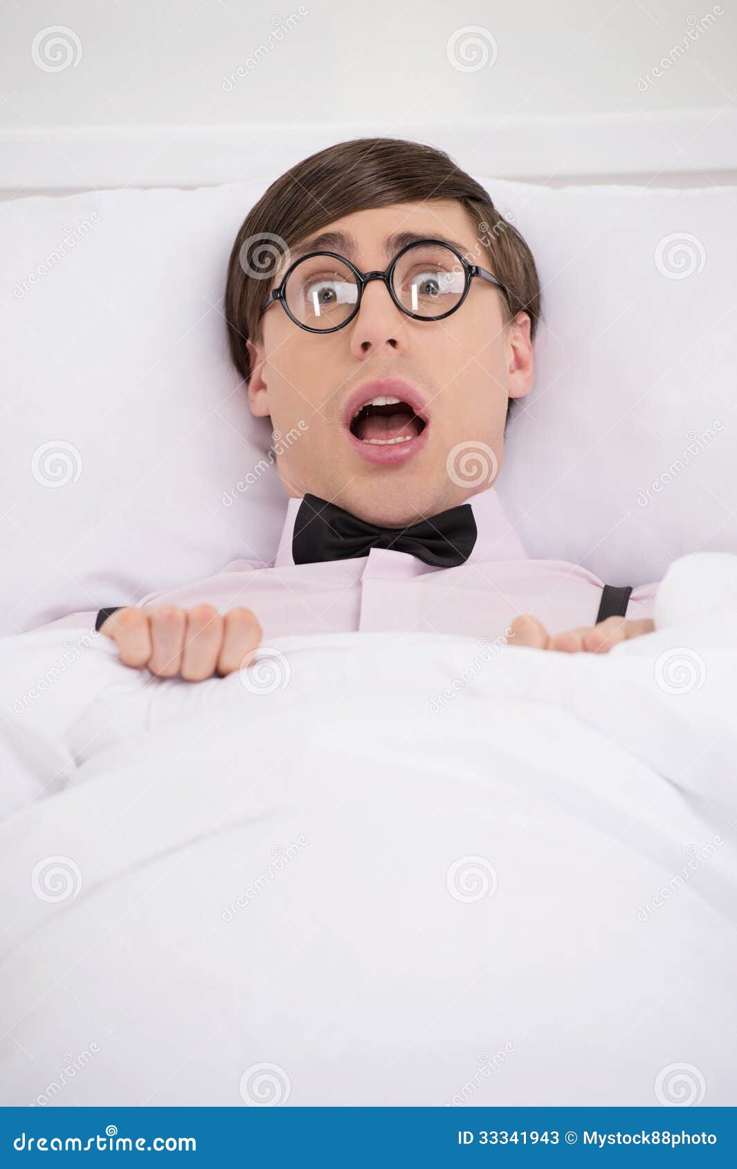 Terrified Nerd. Scared Nerd Lying on the Bed and Looking at Came Stock ...