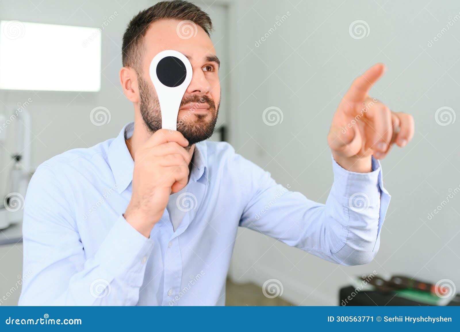 Test of Sight. Man is Checking His Vision Indoors in the Clinic Stock ...