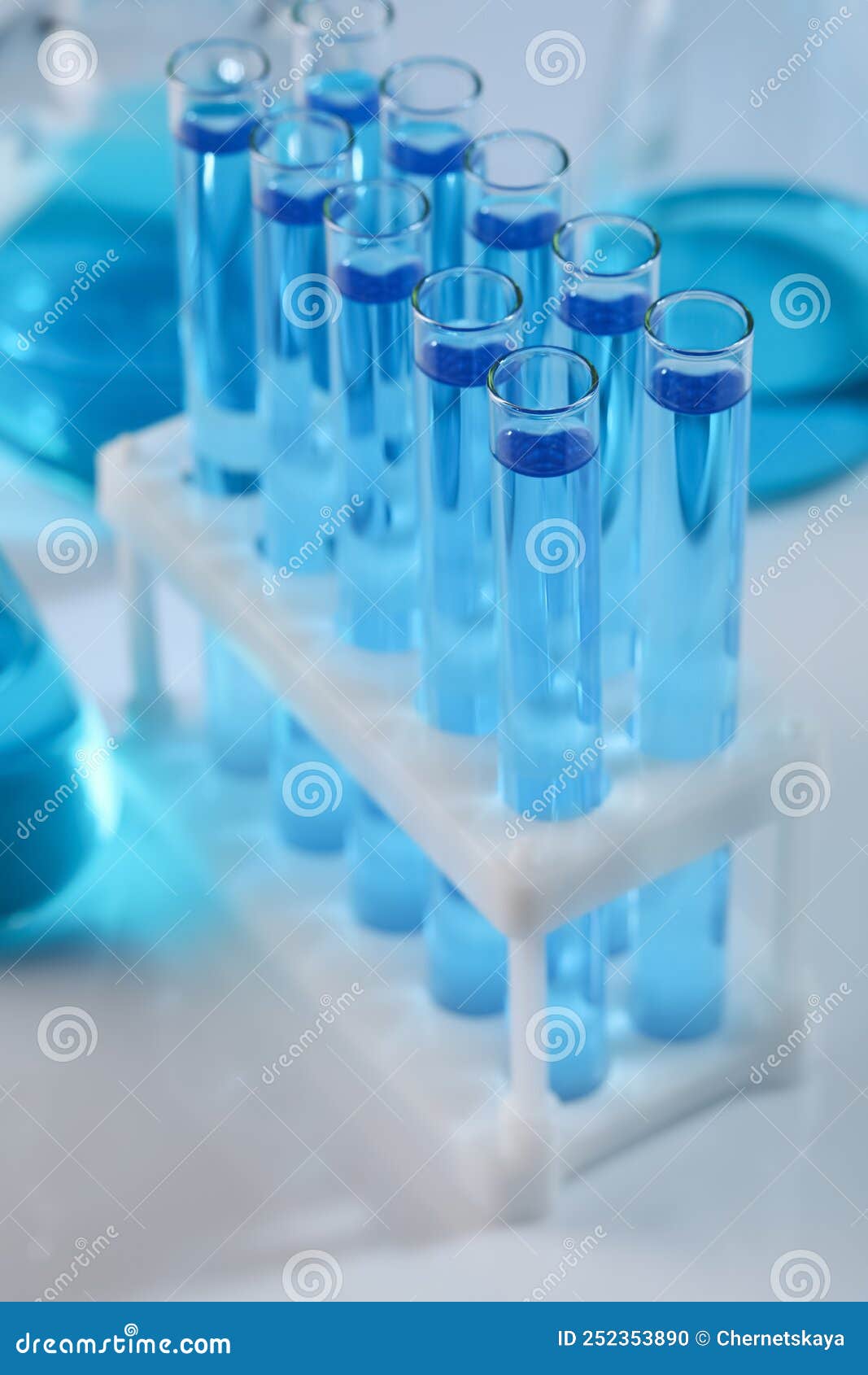 Test Tubes with Blue Liquid on Light Background, Closeup Stock Photo ...