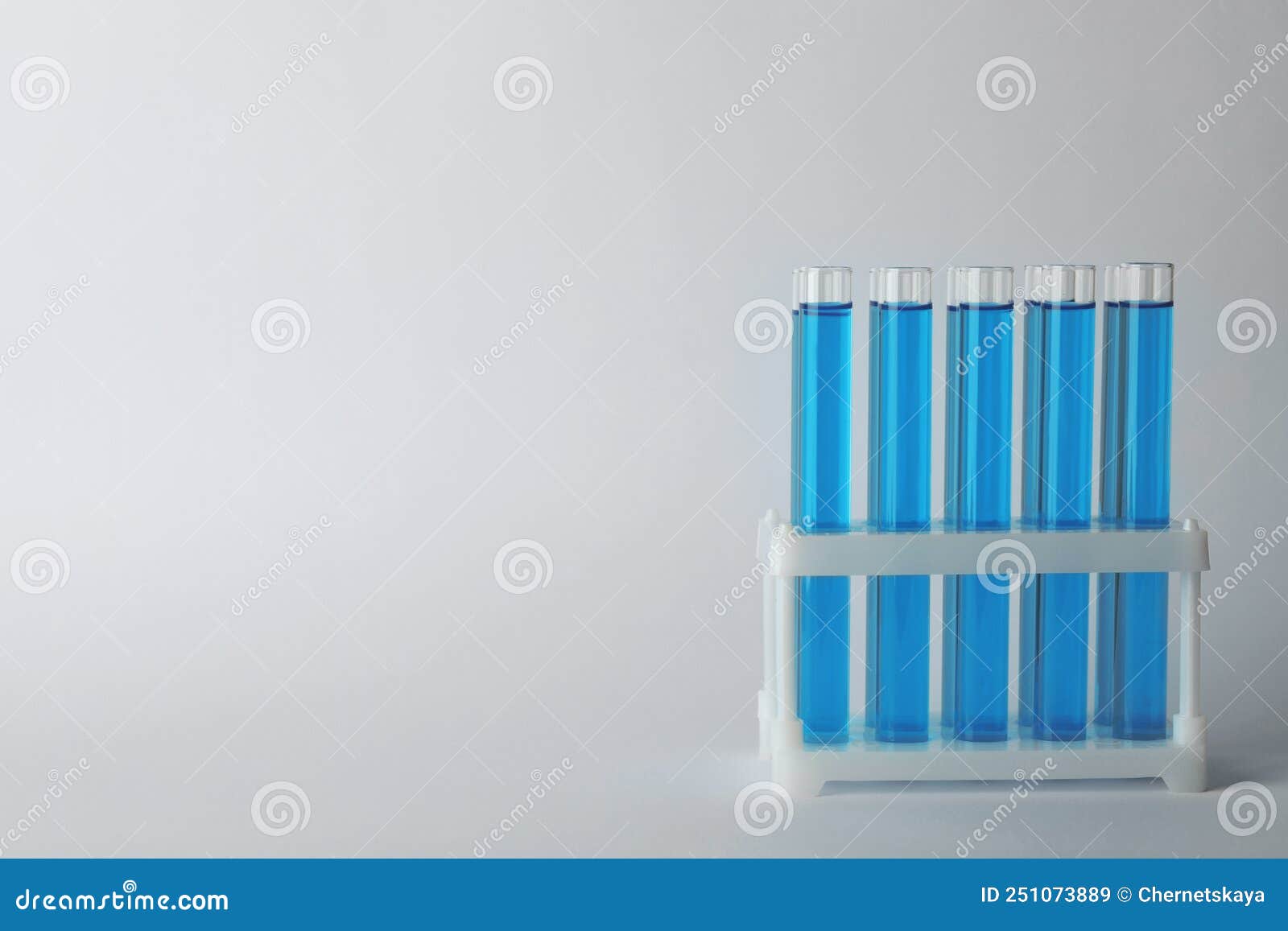 Test Tubes with Blue Liquid on Light Grey Background. Space for Text ...