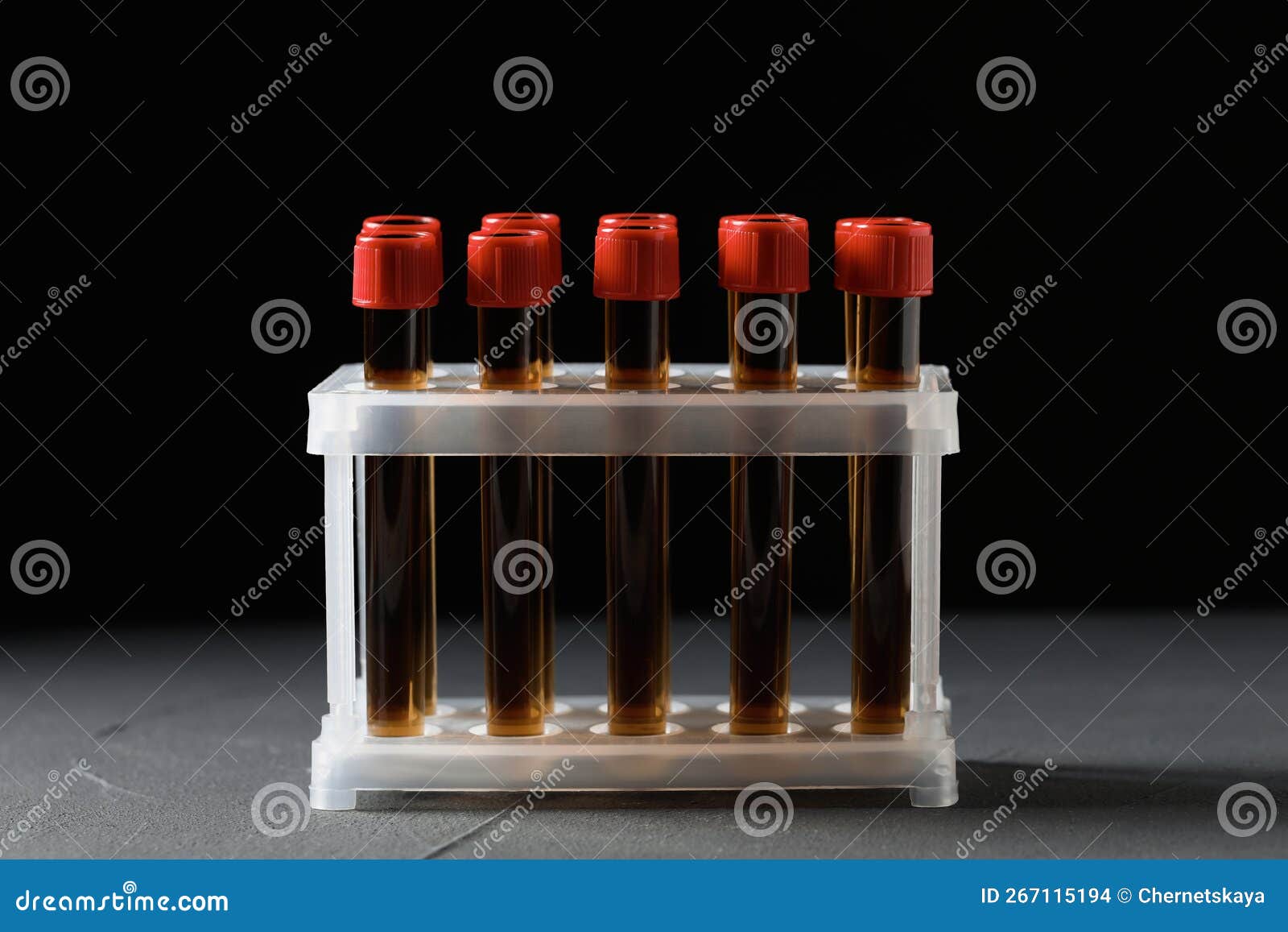 Test Tubes with Brown Liquid in Stand on Grey Table Stock Photo - Image ...
