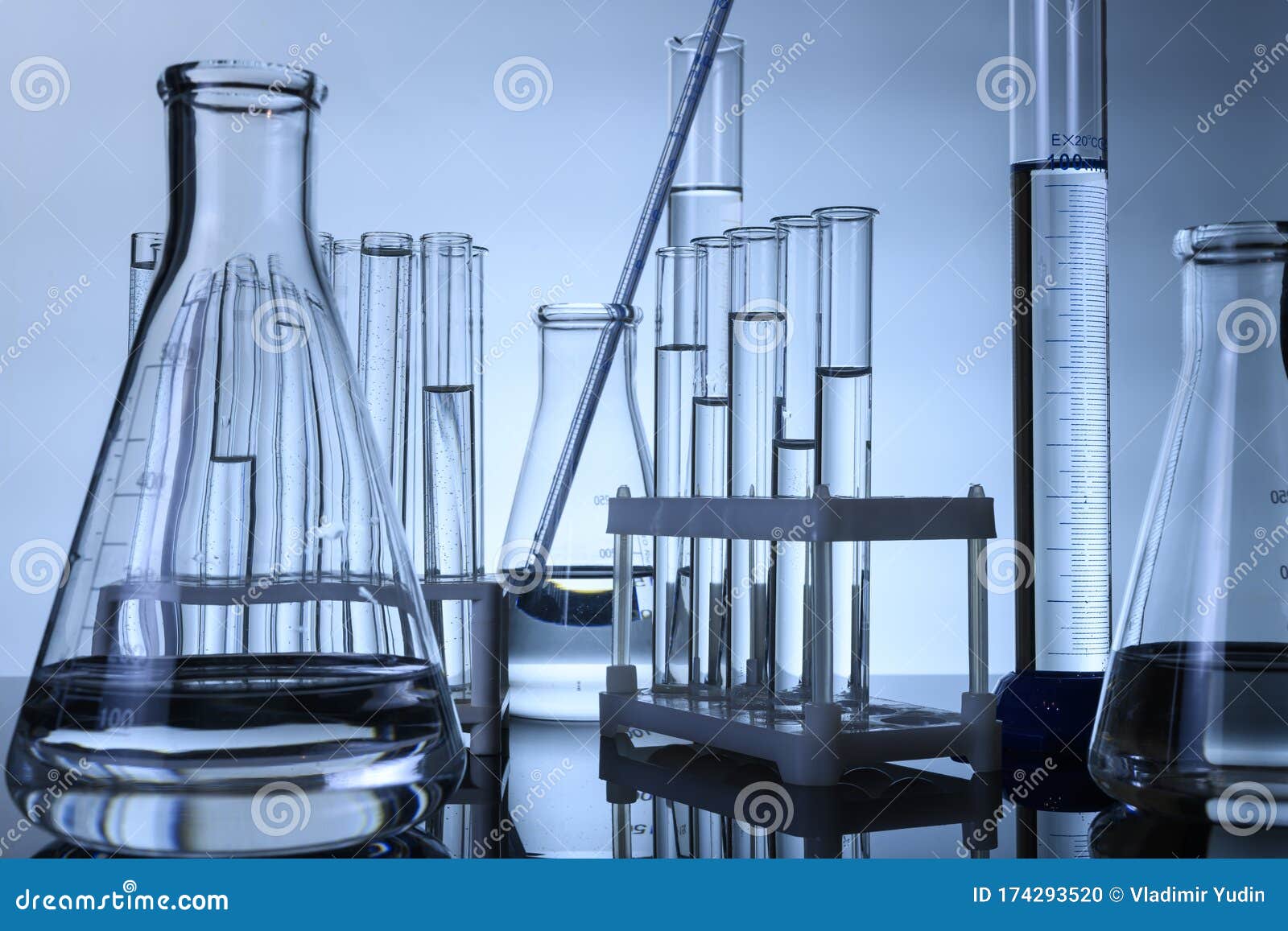 Test Tubes and Flasks Stand with Clear Liquids on a Table in a ...