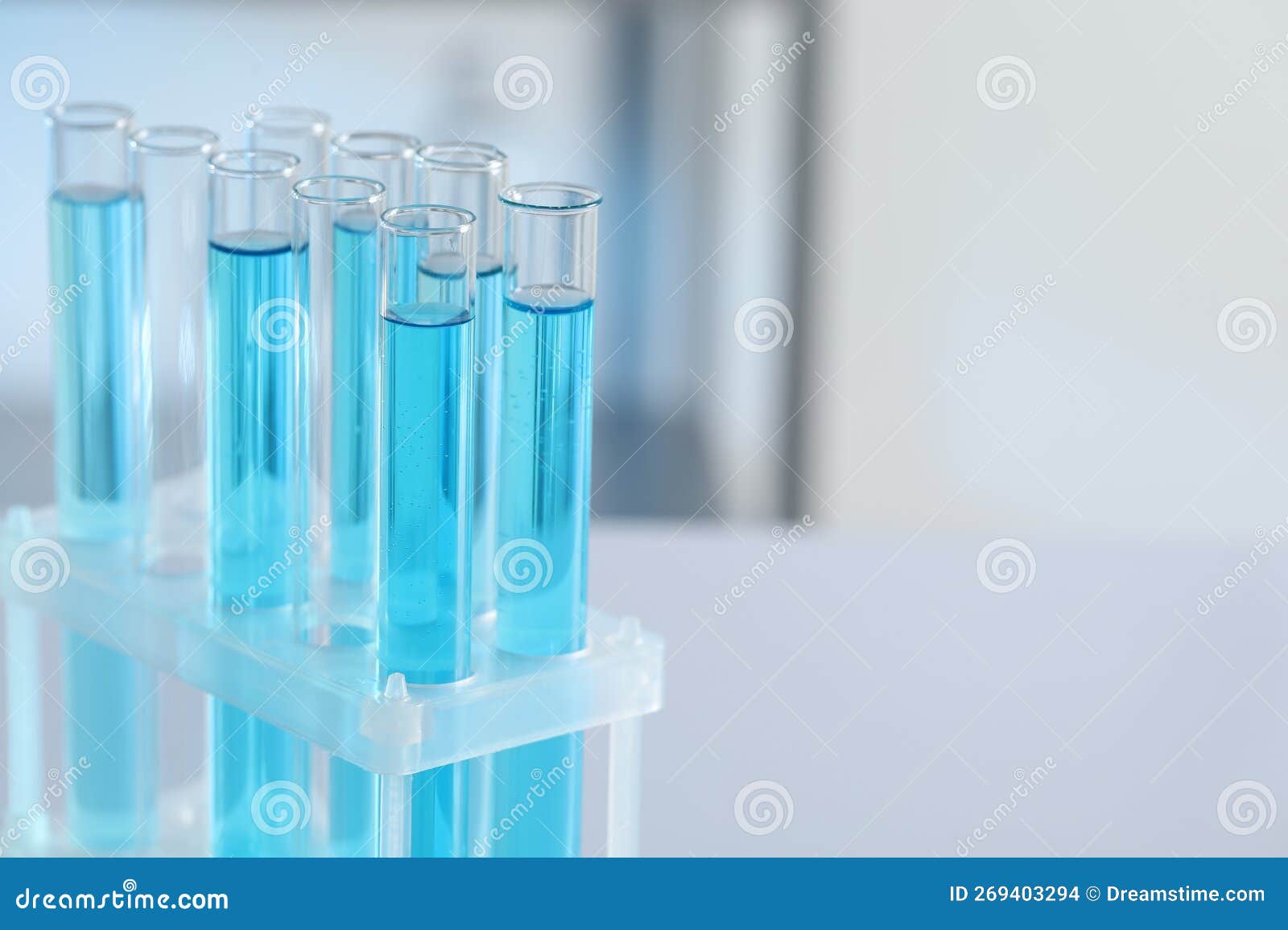 Test Tubes with Light Blue Liquid in Laboratory, Closeup. Space for ...