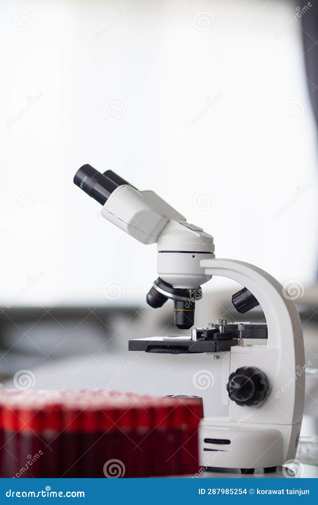 Test Tubes and Microscope are Placed on White Table in Lab To Prepare ...