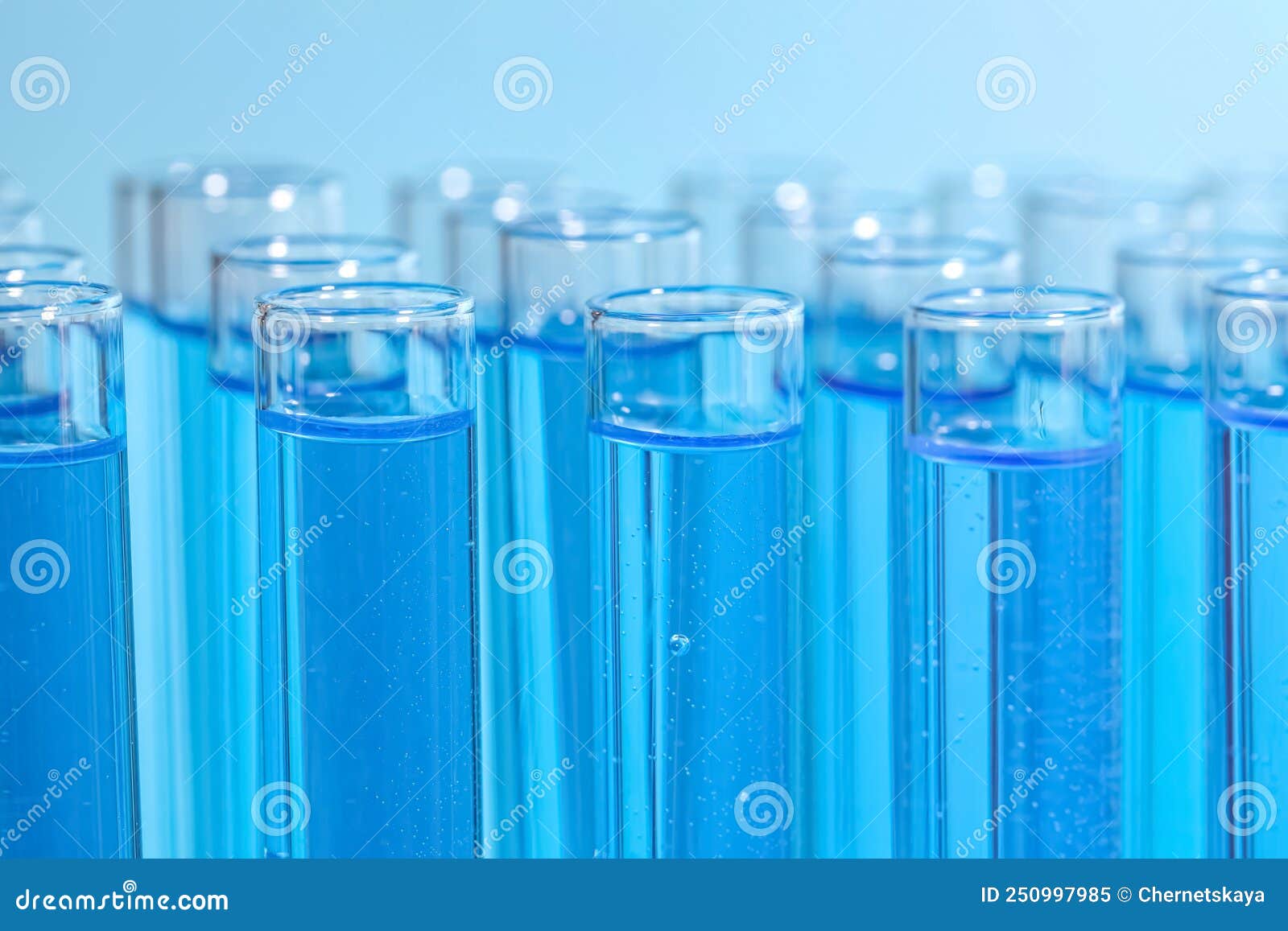 Test Tubes with Reagents on Light Blue Background, Closeup. Laboratory ...