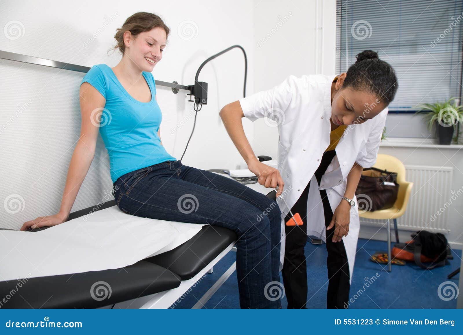 Testing her reflexes stock image. Image of practitioner - 5531223