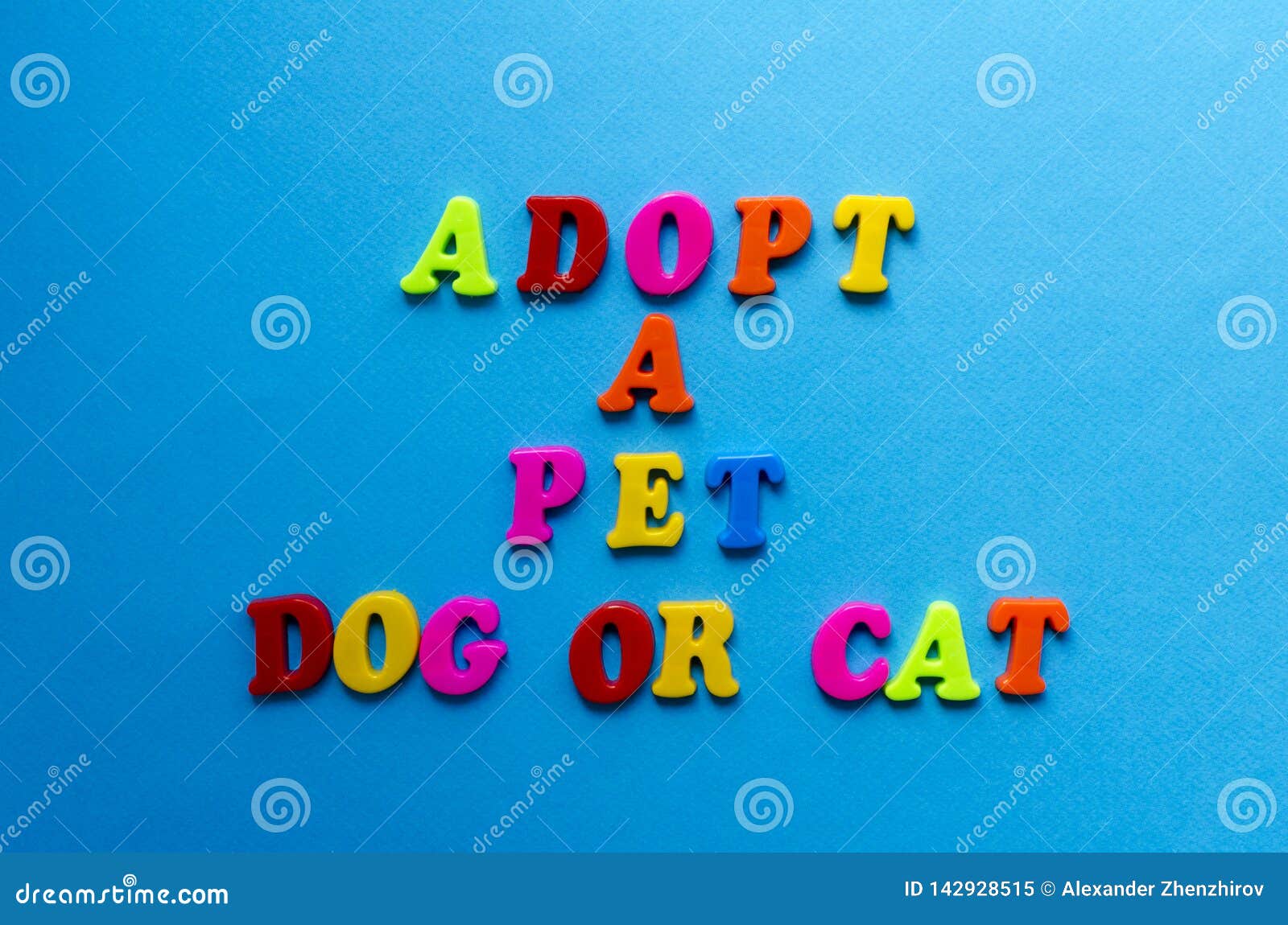 Text Adopt a Pet Dog or Cat from Plastic Colored Letters on Blue Paper ...