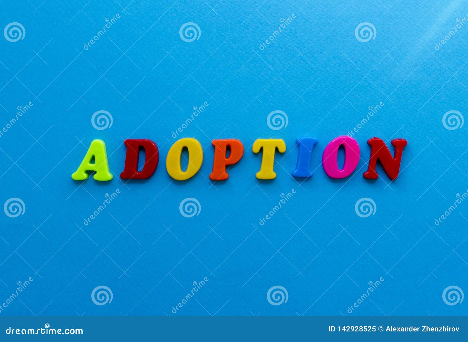 Text Adoption from Plastic Colored Letters on Blue Paper Background ...
