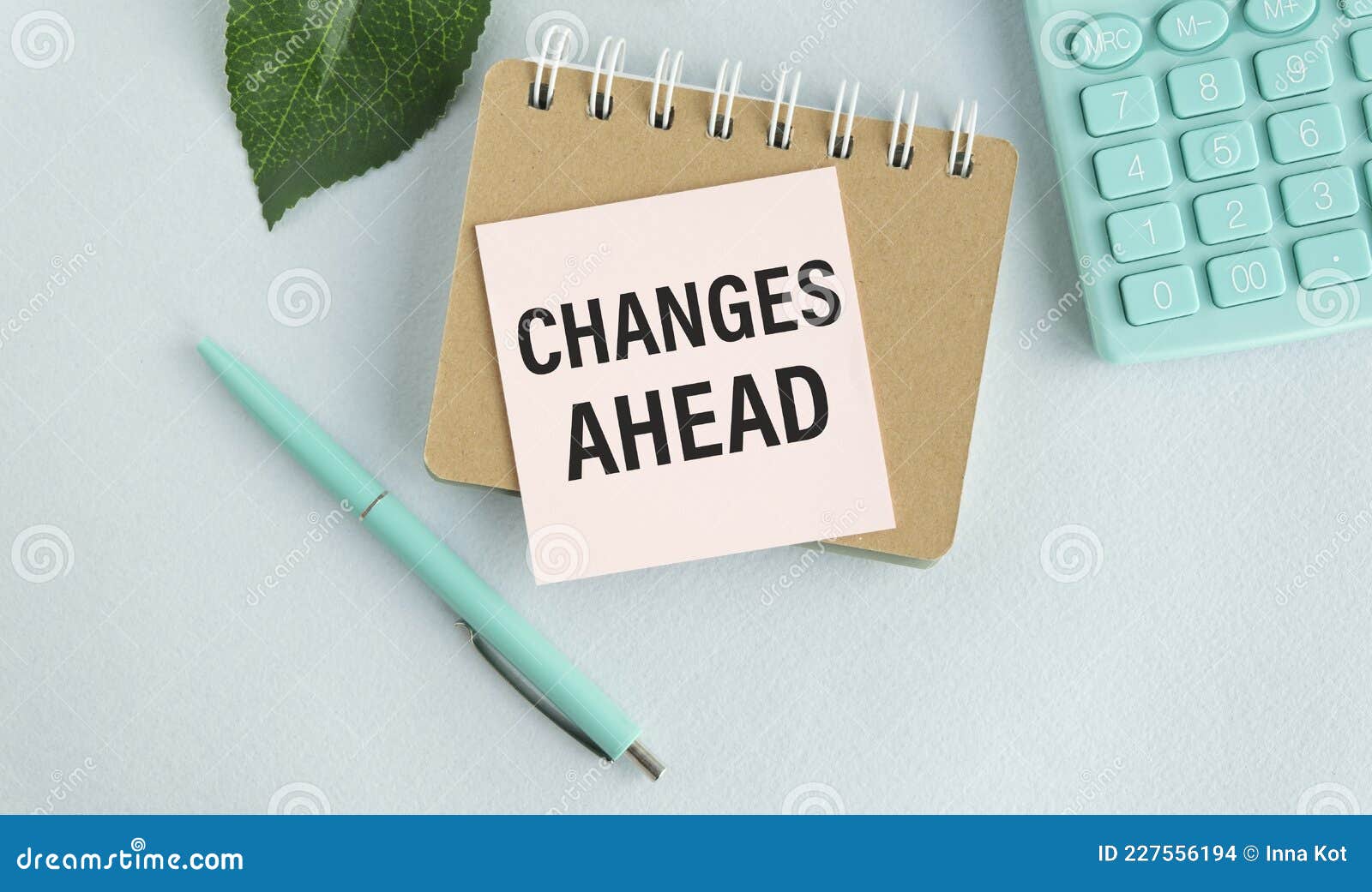 Text Changes Ahead on White Paper Sheet and Brown Paper Notepad on the ...